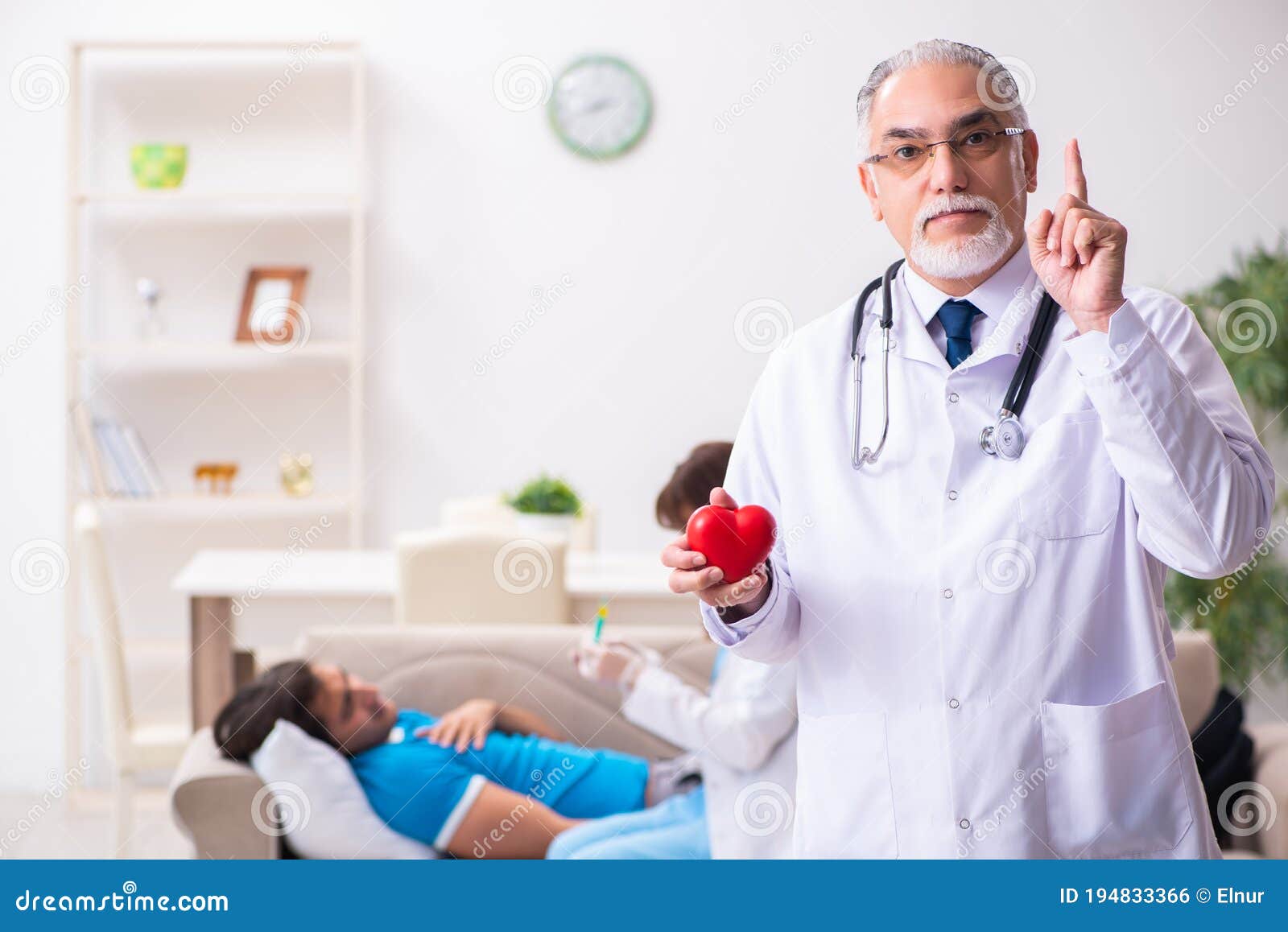 Two Doctors Visiting Sick Young Man at Home Stock Photo - Image of ...