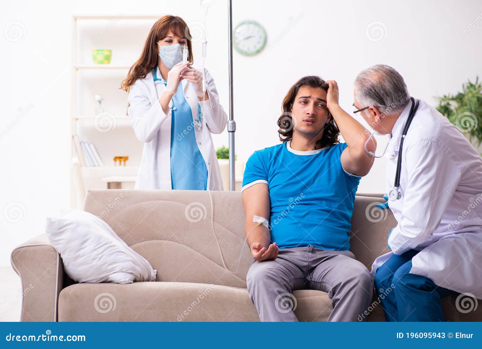 Two Doctors Visiting Sick Young Man at Home Stock Image - Image of ...