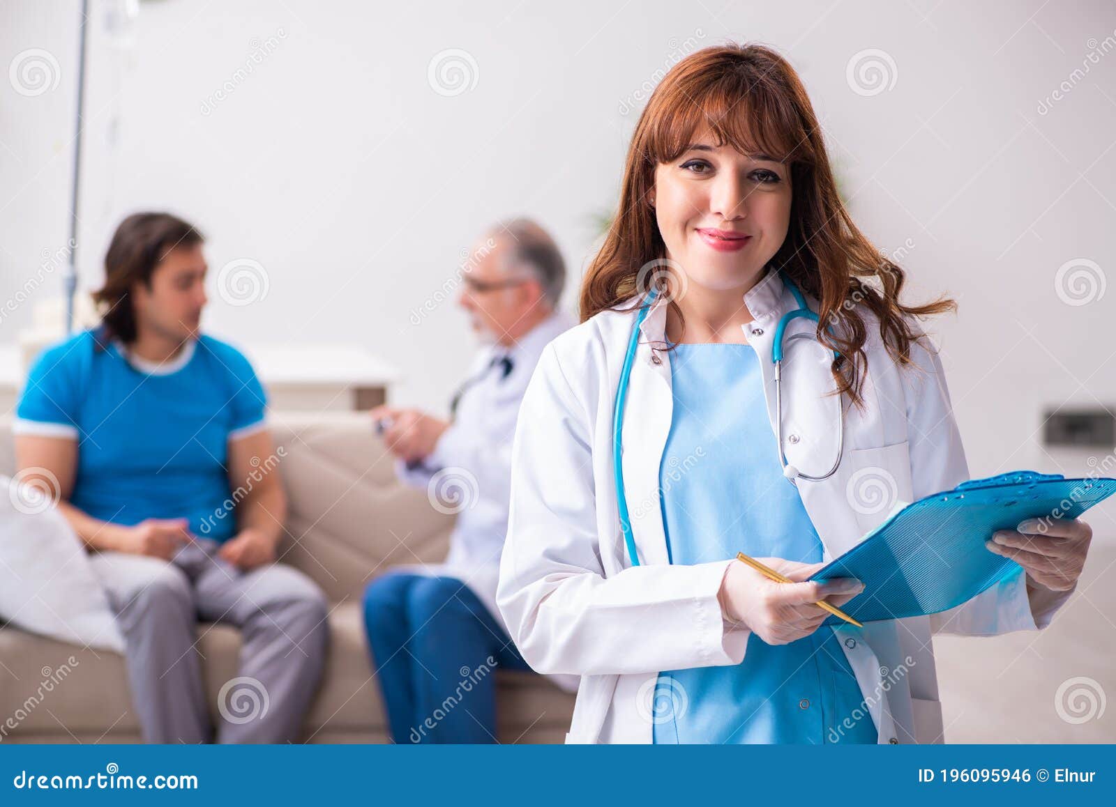 Two Doctors Visiting Sick Young Man at Home Stock Photo - Image of ...