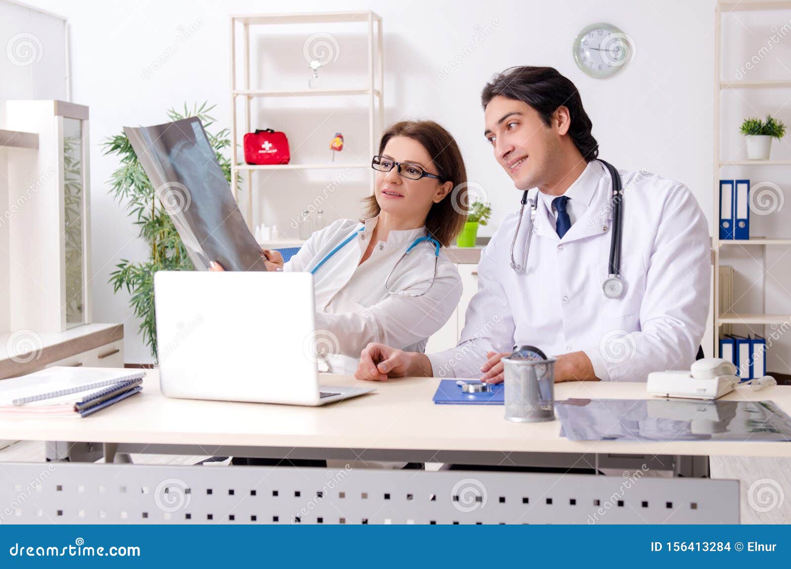 Two Doctors Working in the Clinic Stock Photo - Image of looking ...