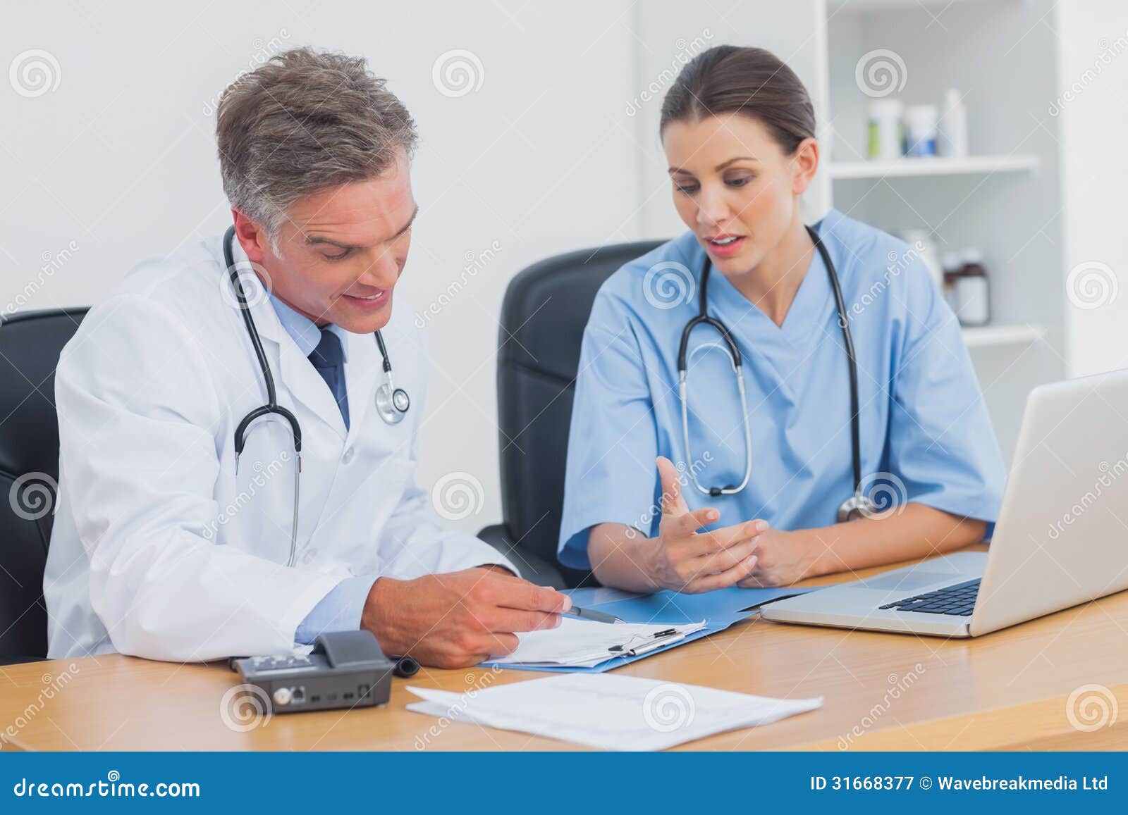 Two Doctors Working on an Important Folder Stock Image - Image of ...