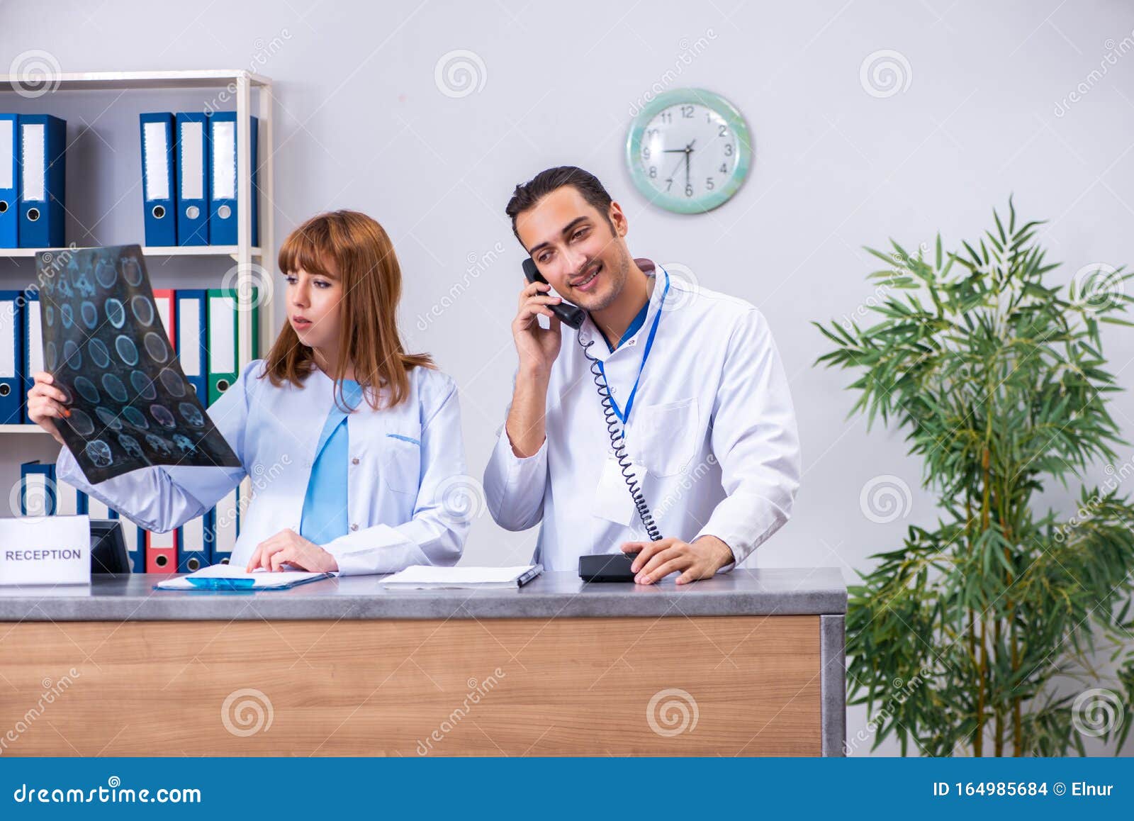 Two Doctors Working at the Reception in the Hospital Stock Photo ...