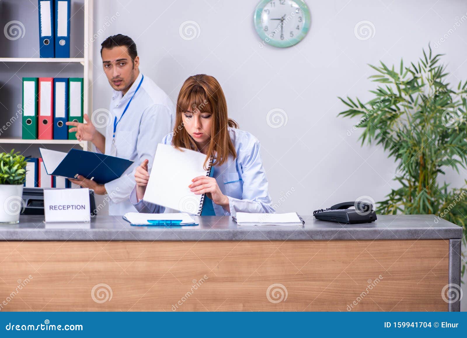 Two Doctors Working at the Reception in the Hospital Stock Photo ...