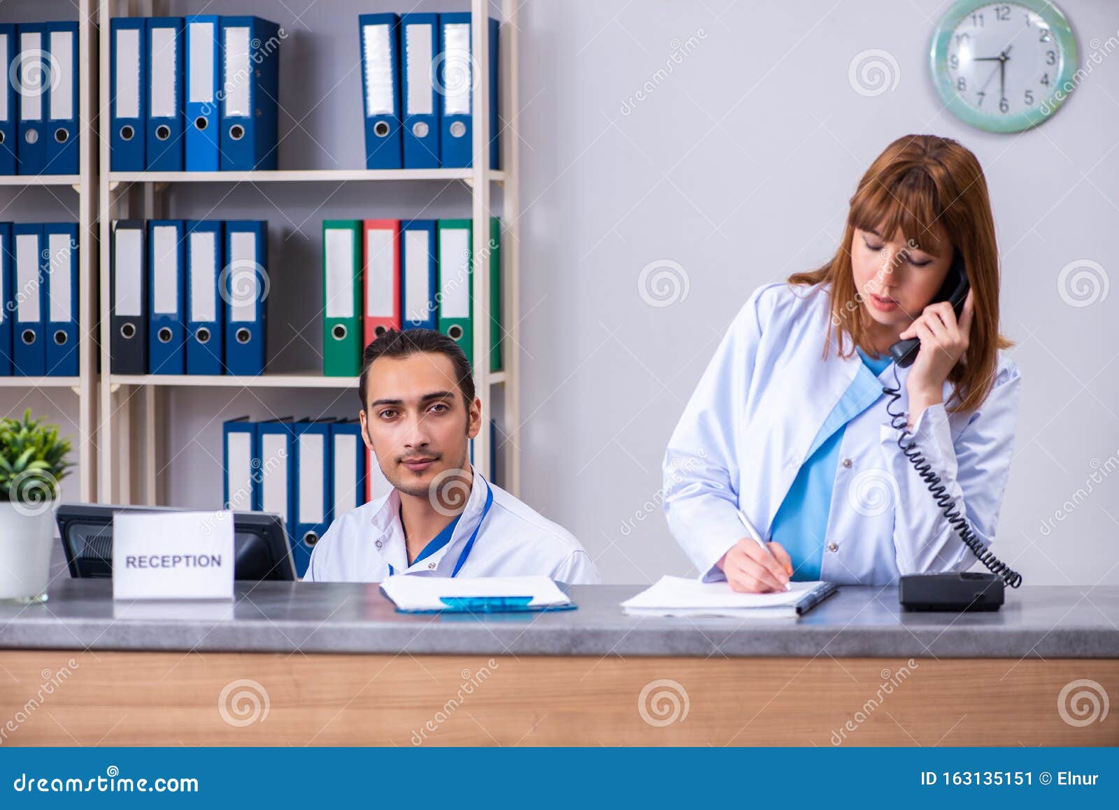 Two Doctors Working at the Reception in the Hospital Stock Image ...
