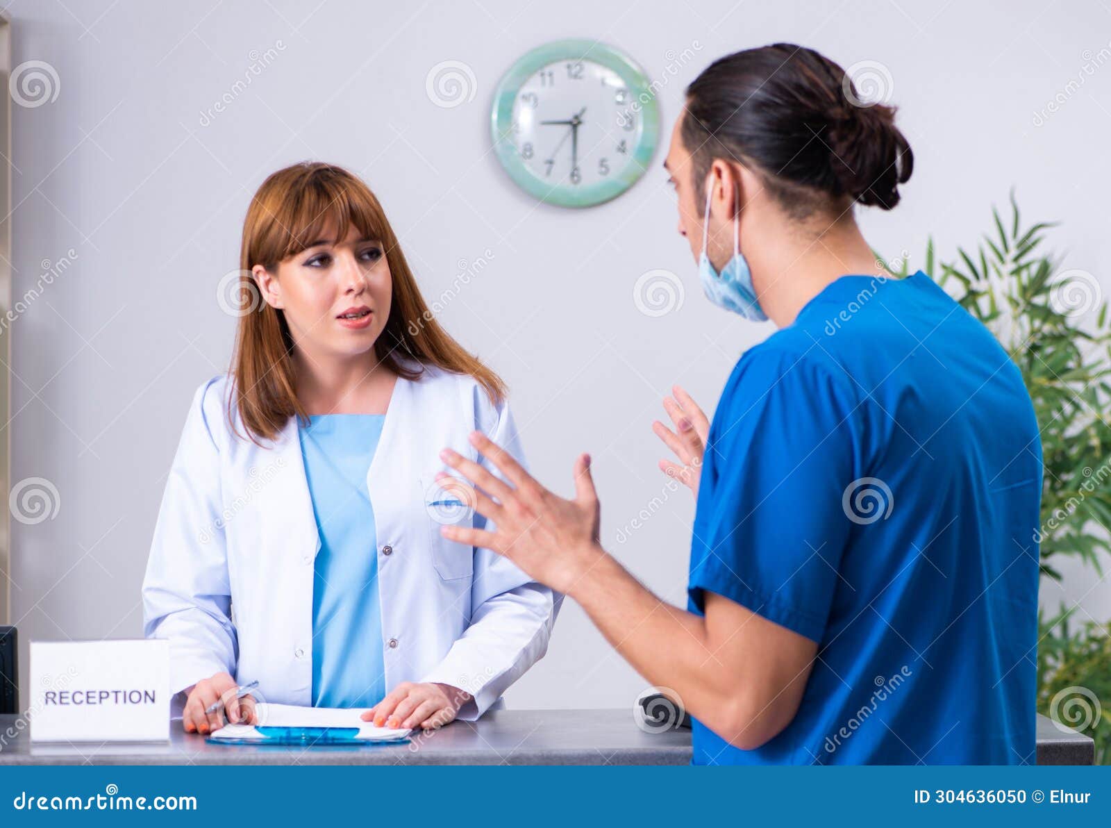 Two Doctors Working at the Reception in the Hospital Stock Photo ...
