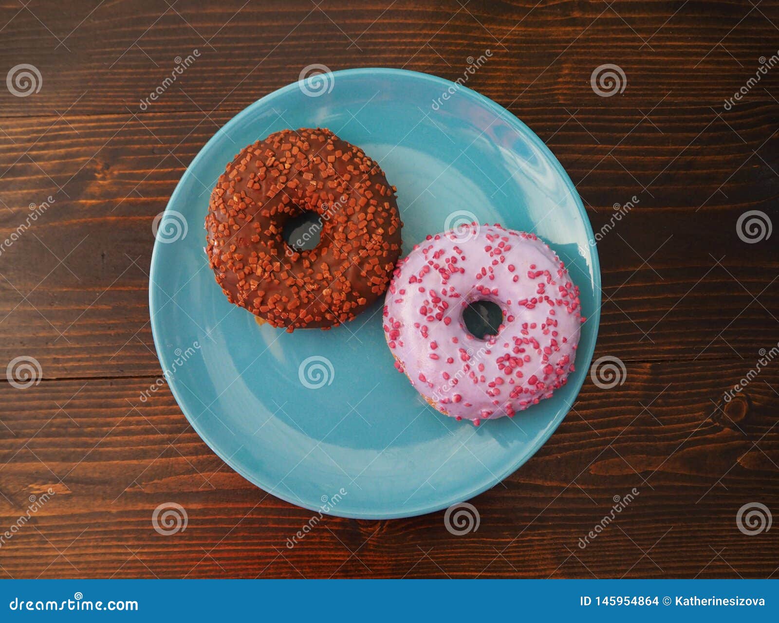Two Donuts on the Blue Plate Stock Photo - Image of tasty, food: 145954864