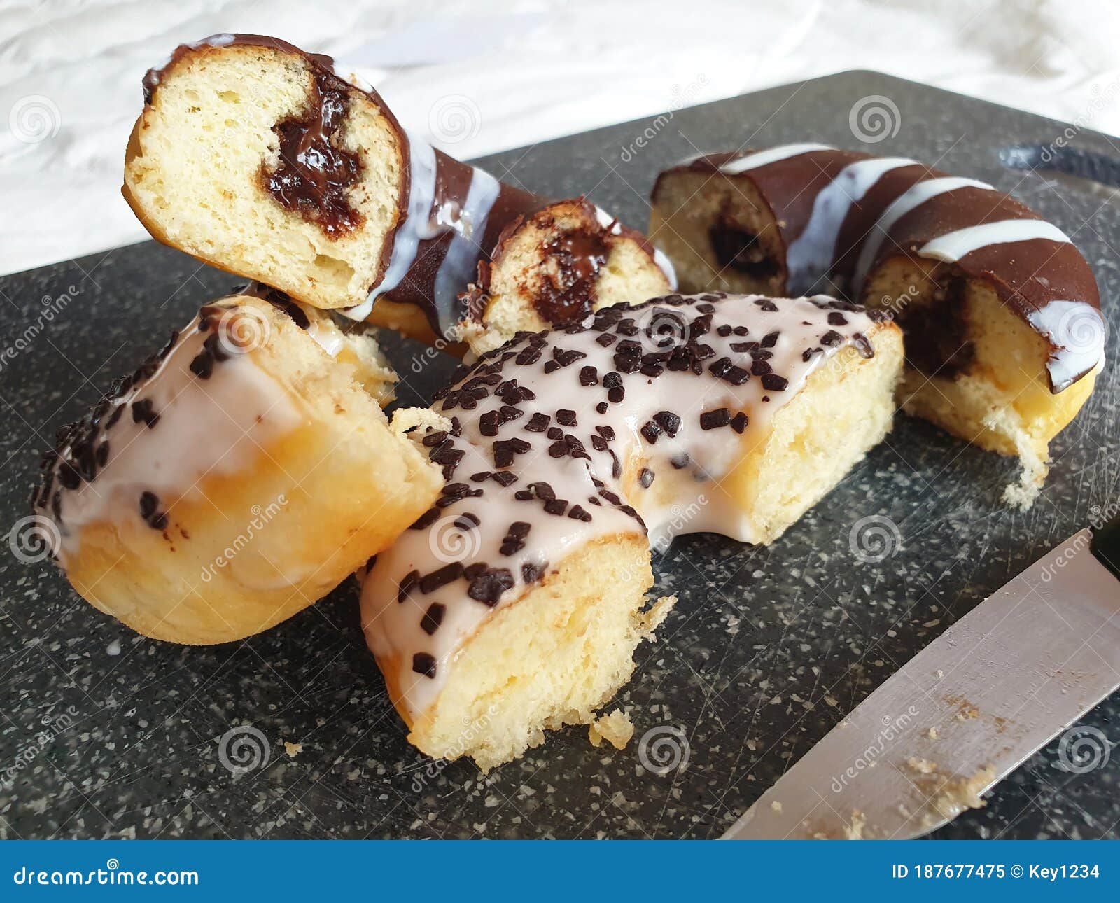 Two doughnuts cut in half stock image. Image of measure - 187677475