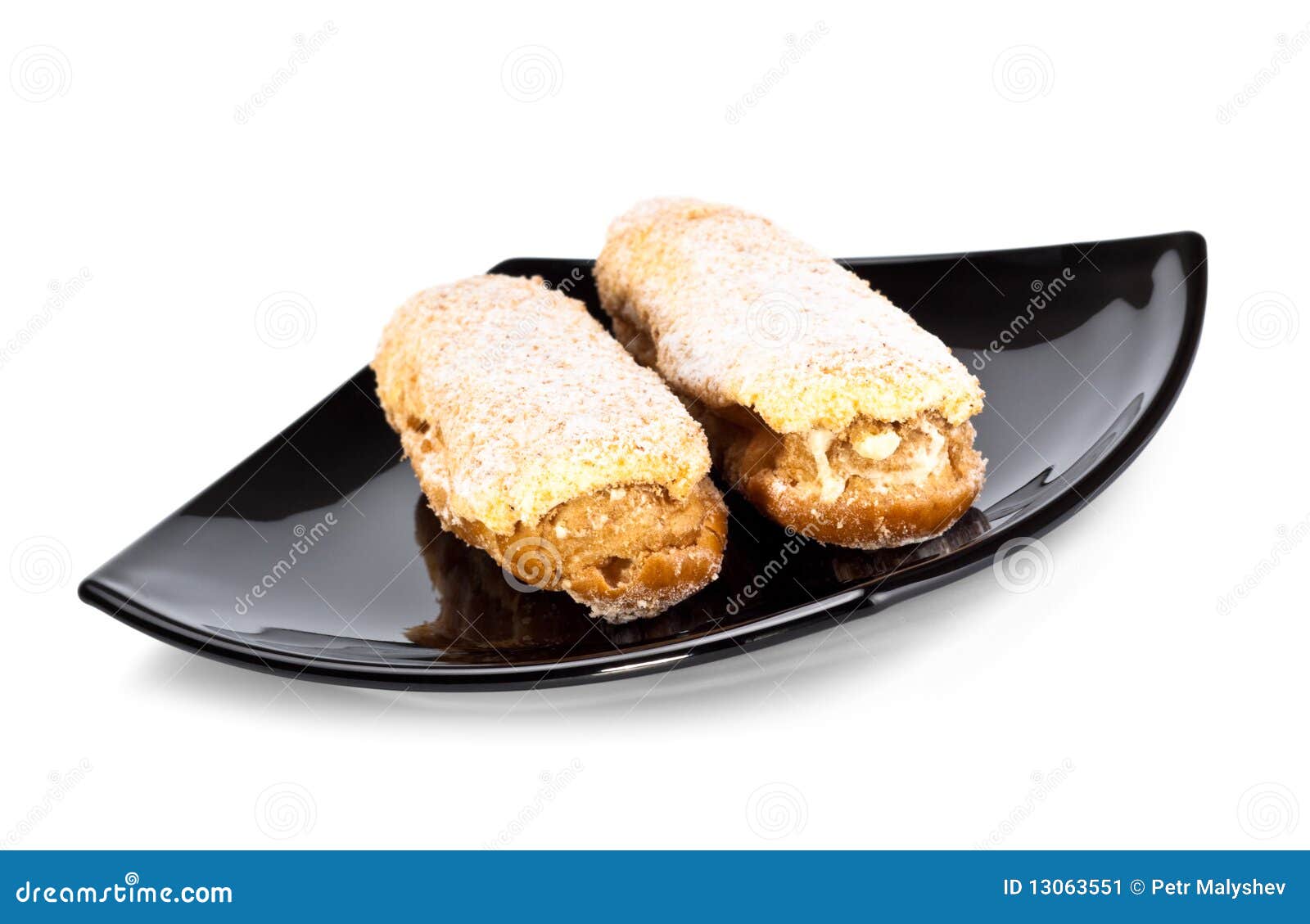 Two eclairs on black dish stock image. Image of delicious - 13063551
