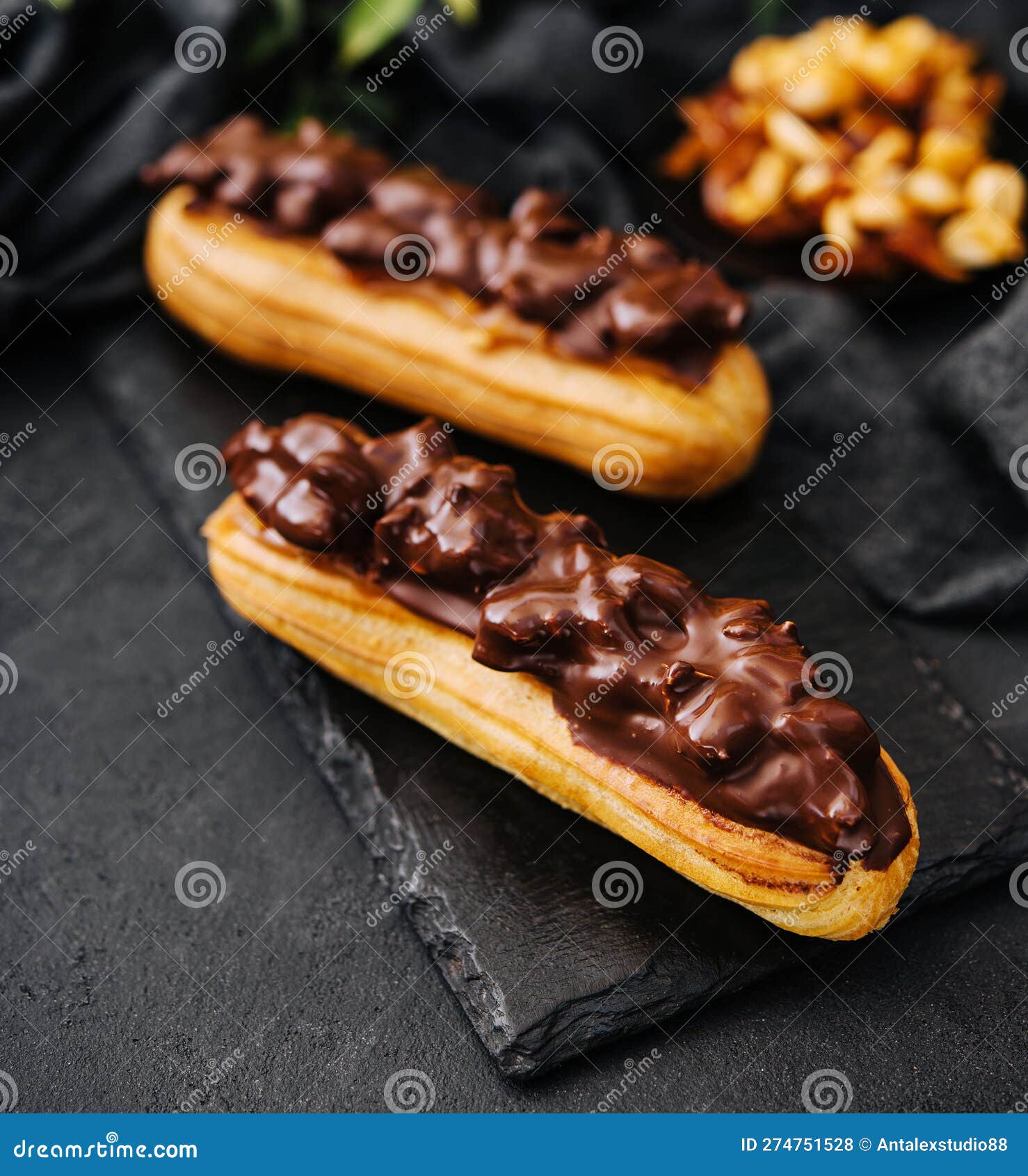 Two Eclairs with Dark Chocolate on Black Board Stock Photo - Image of ...