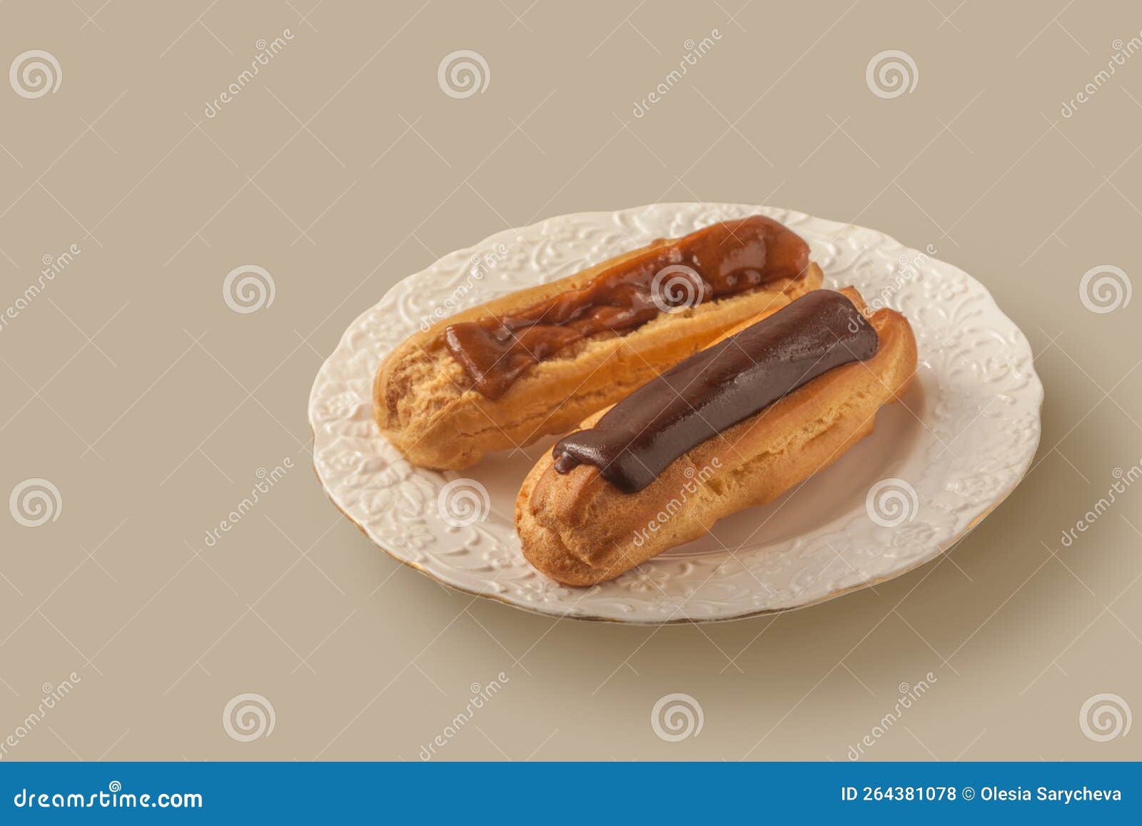 Two Eclairs with Different Types of Fudge on a White Vintage Plate on a ...