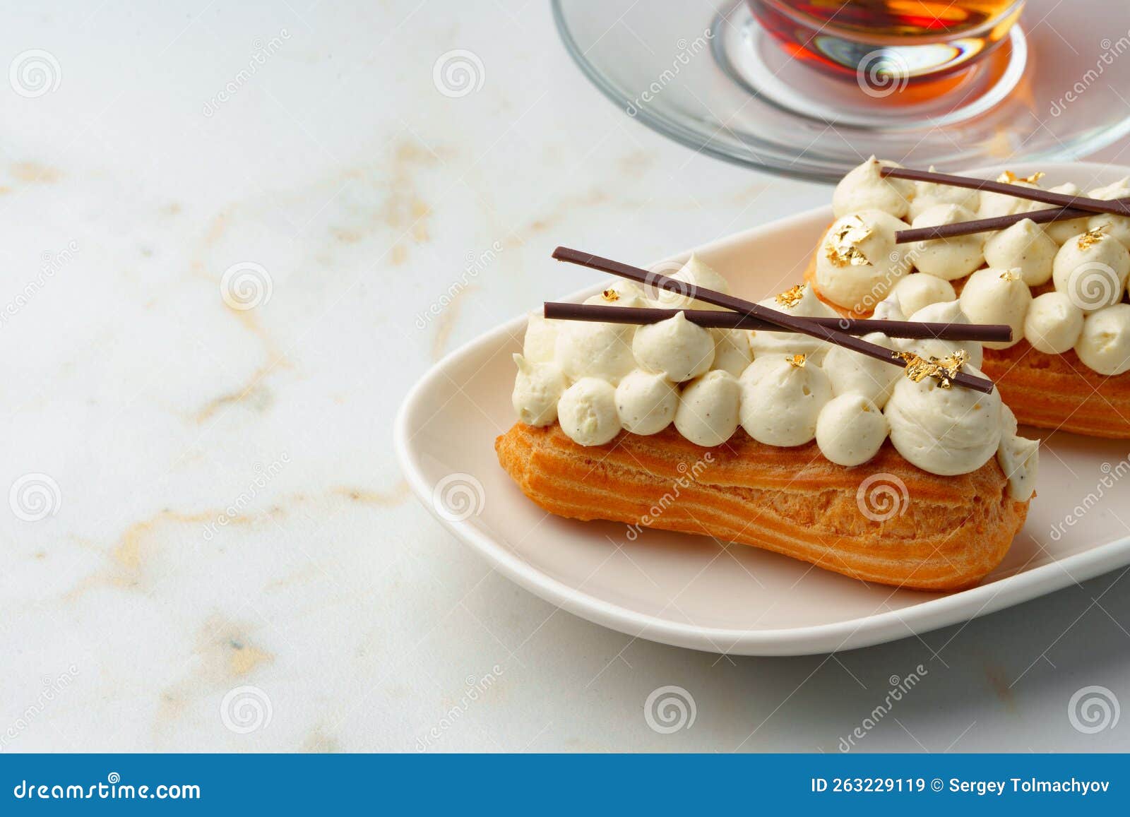 Two Eclairs with White Custard on Whhite Plate Close Up Stock Image ...
