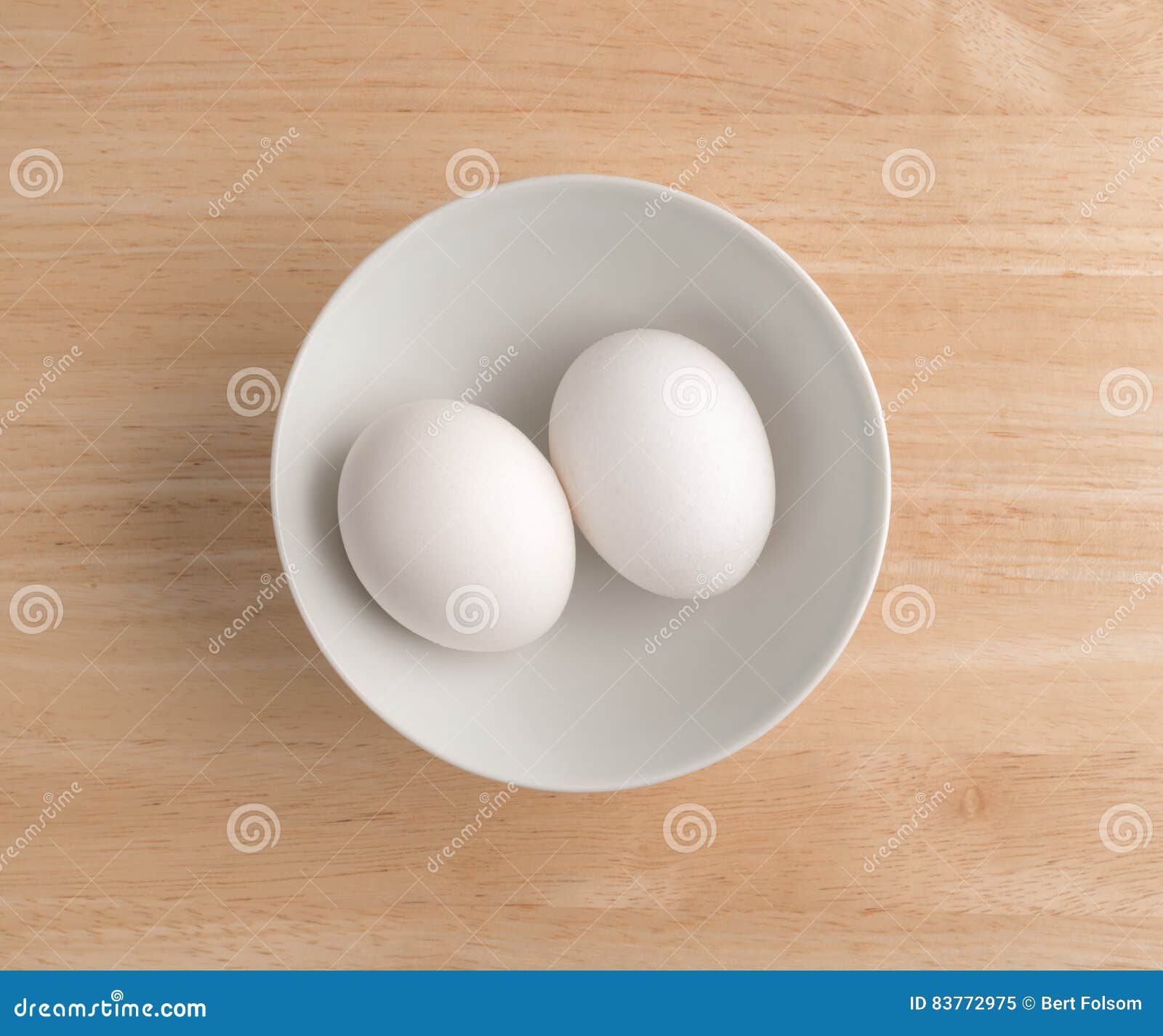 Two Eggs in a Bowl Atop a Wood Table Top. Stock Image - Image of bowl ...