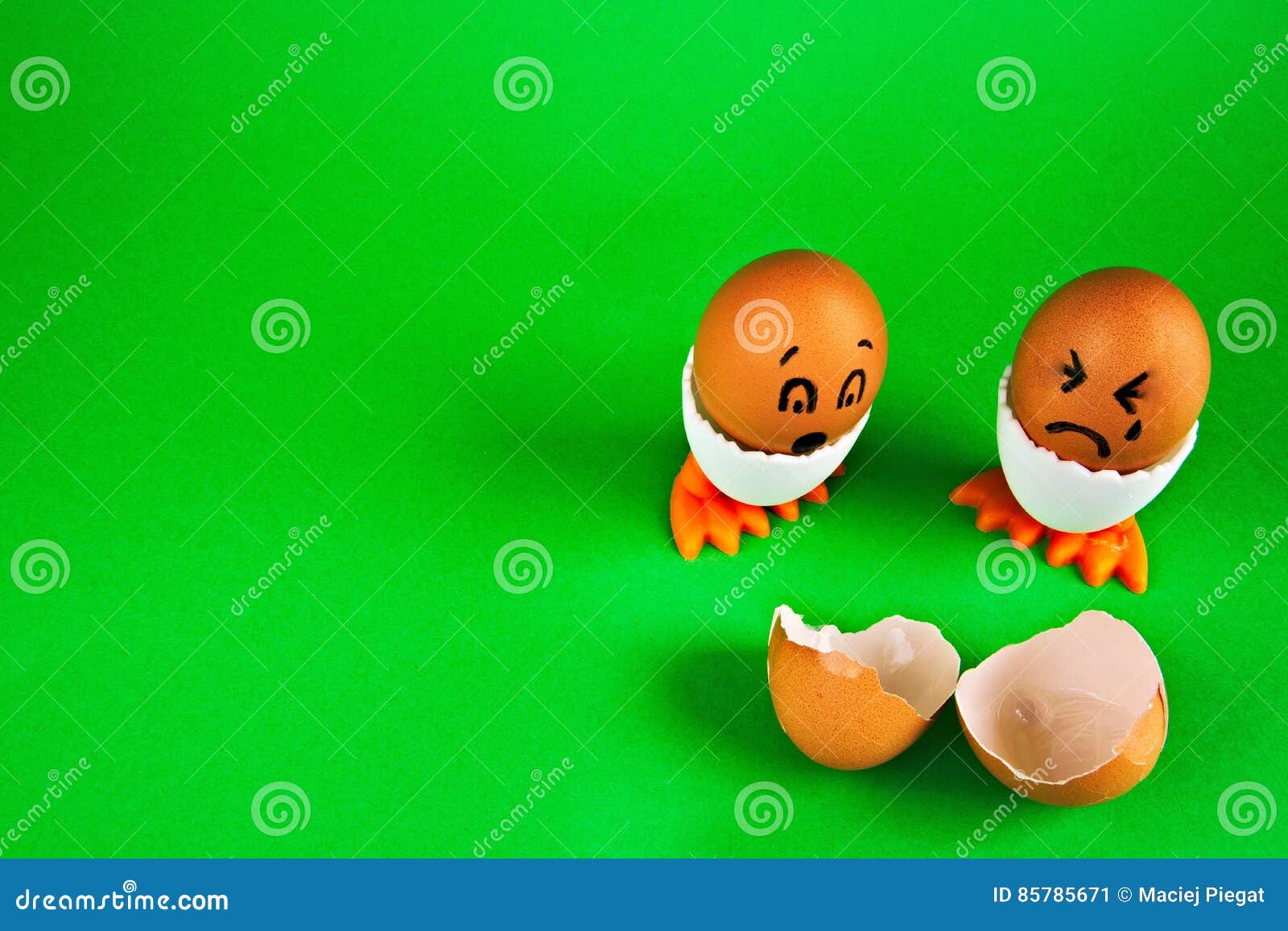 Two Eggs in Stands with Faces on a Green Backround Stock Image - Image ...