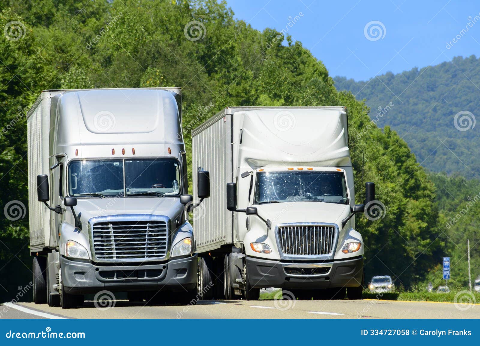 Two Eighteen Wheeler Semi Trucks Motor Down the Interstate Highway ...