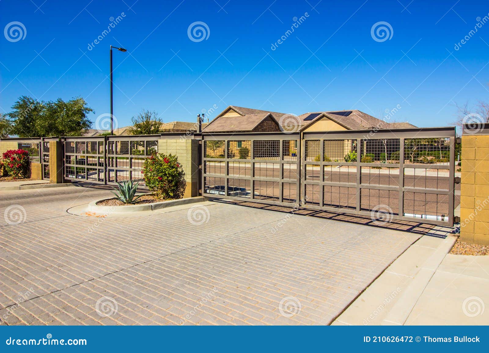 Two Electric Entry/Exit Gates with Brick Driveway Stock Photo - Image ...