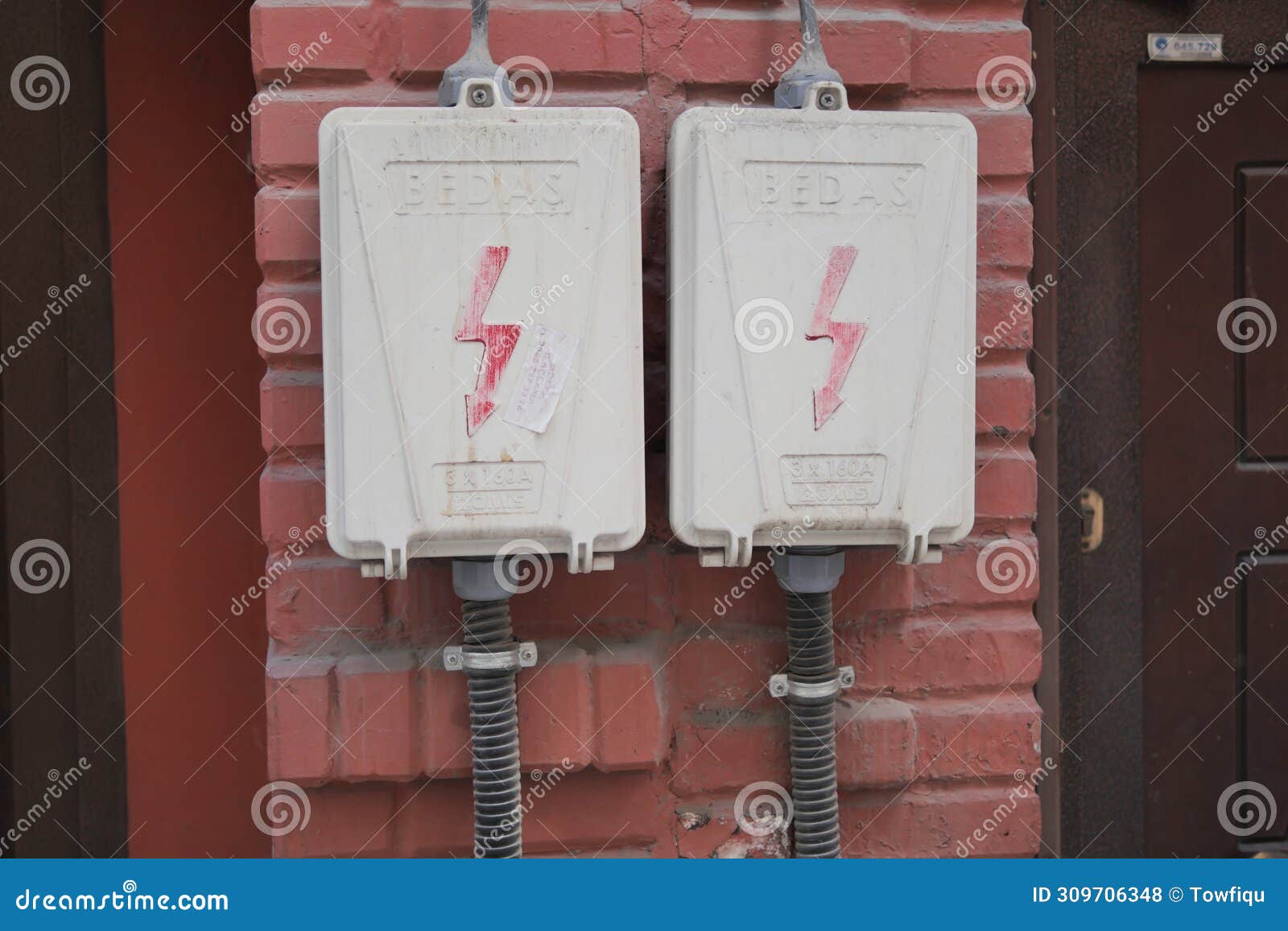 Two Electrical Boxes with Lightning Bolt on Brick Wall Stock Photo ...
