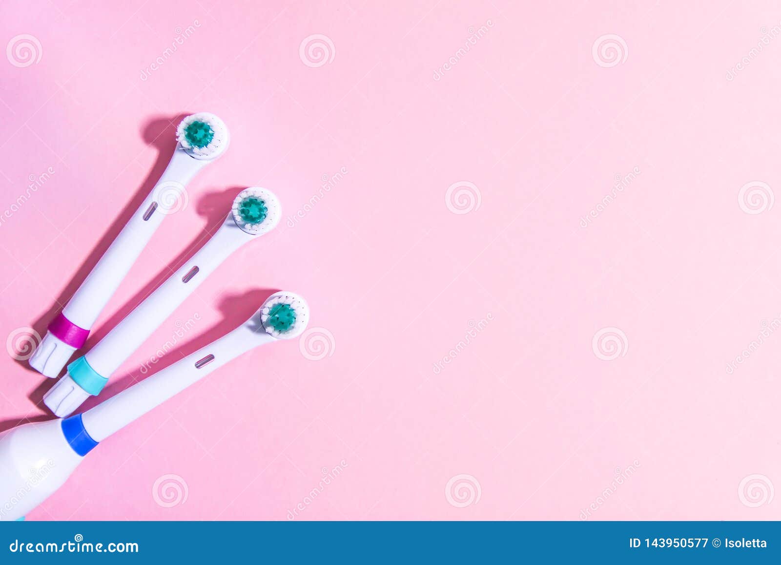 Three Electrical Toothbrushes on a Soft Light Pink Background Stock ...