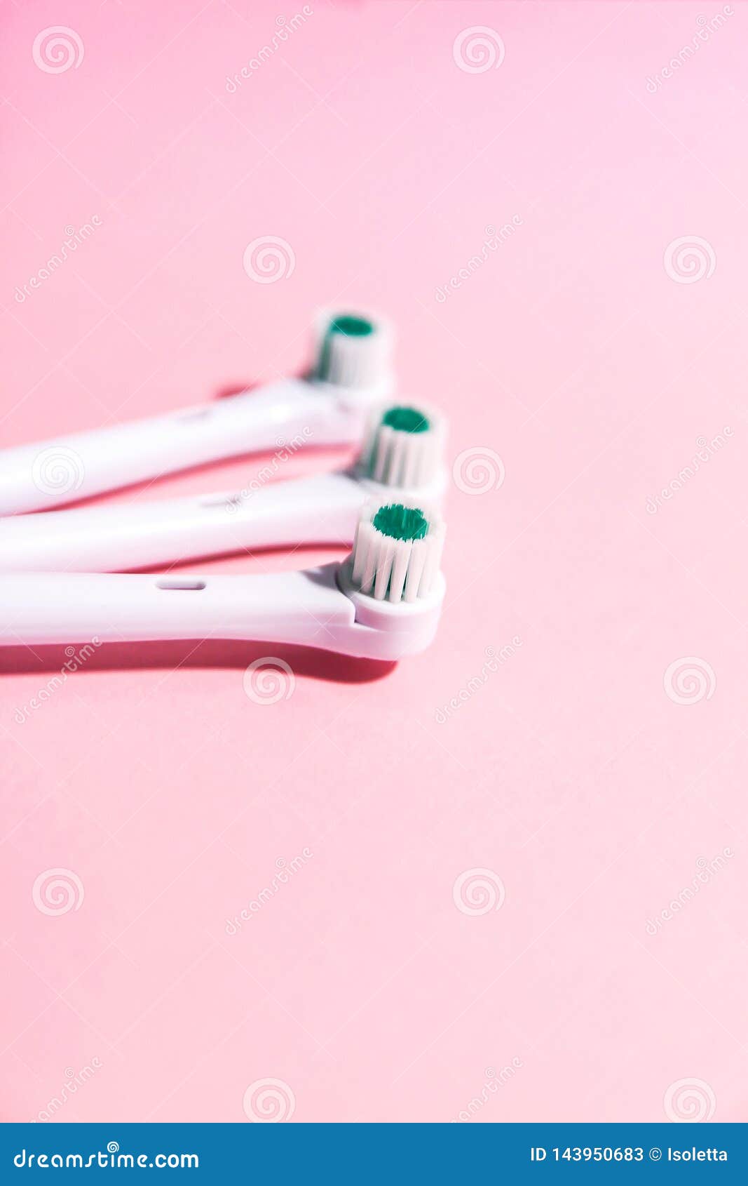 Three Electrical Toothbrushes on a Soft Light Pink Background Stock ...