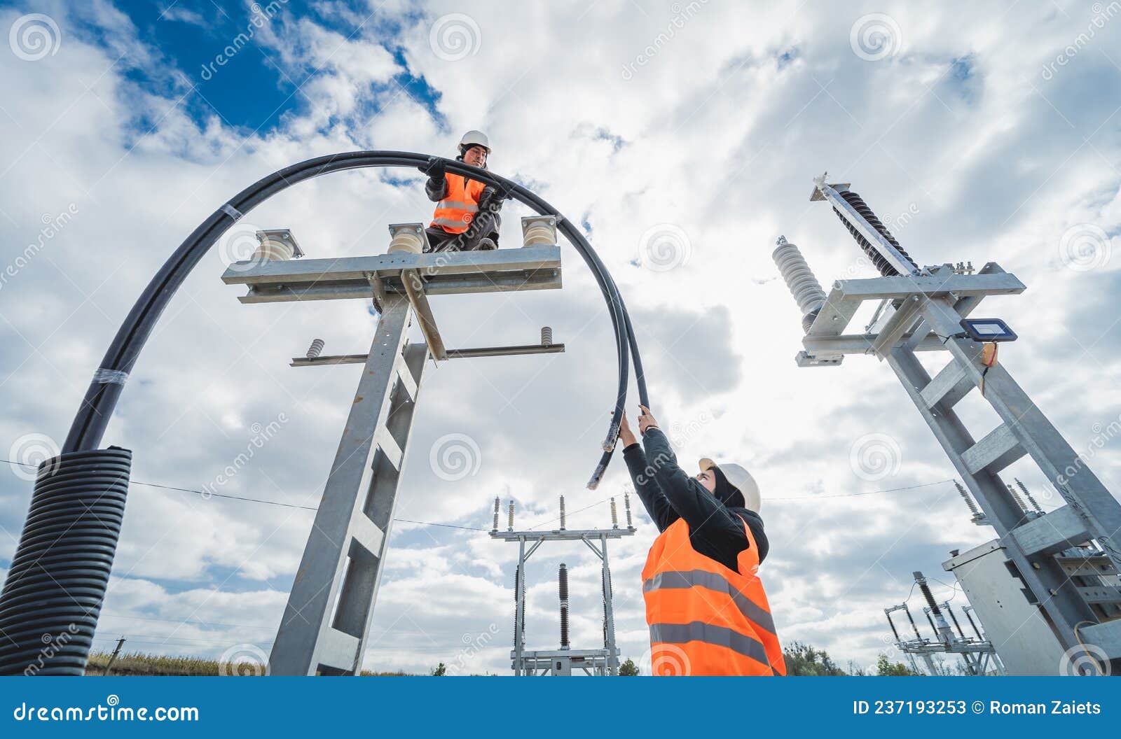 Two Electrician Builder Workers Installing High-voltage Cable Stock ...
