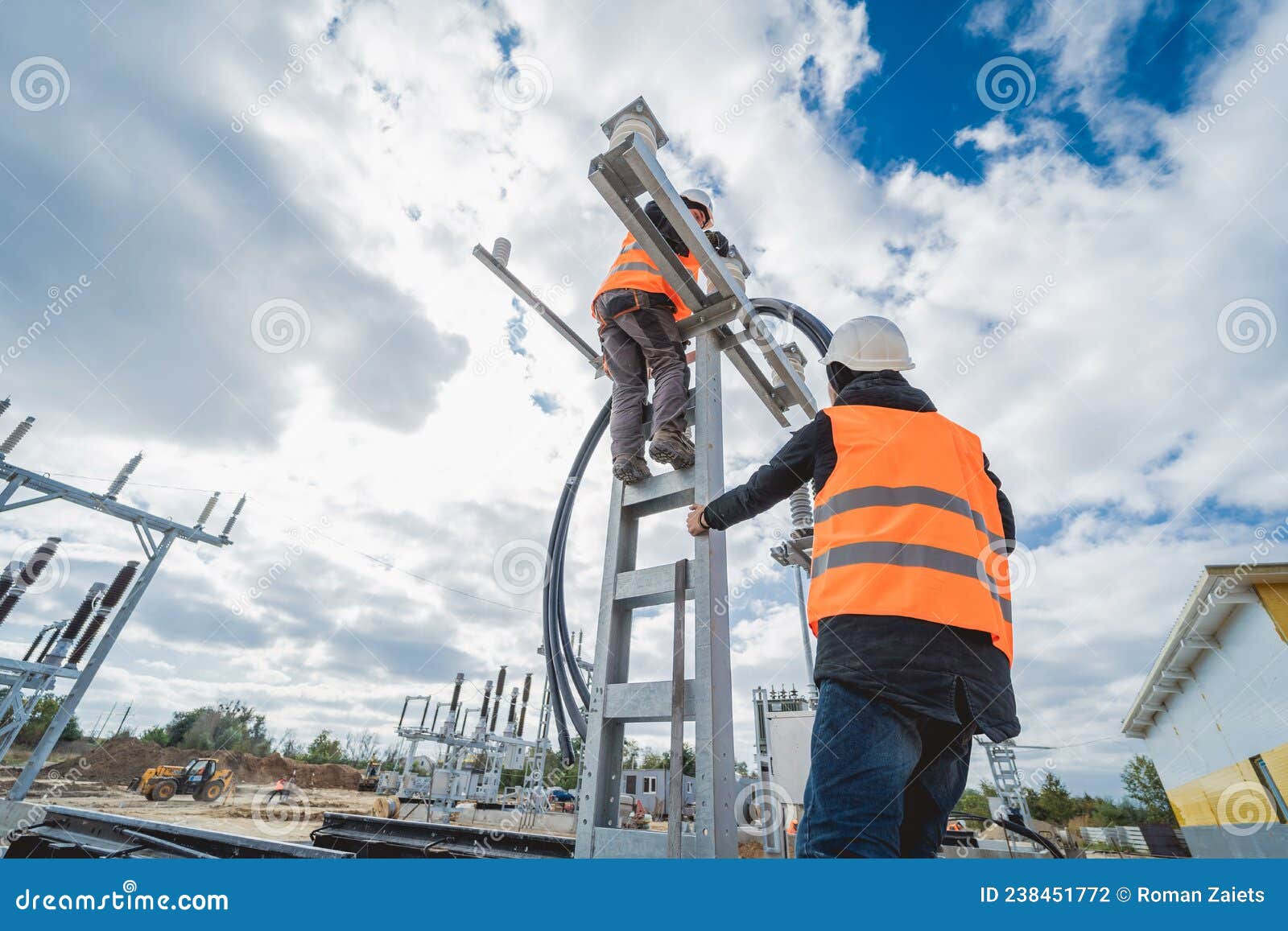 Two Electrician Builder Workers Installing High-voltage Cable Stock ...