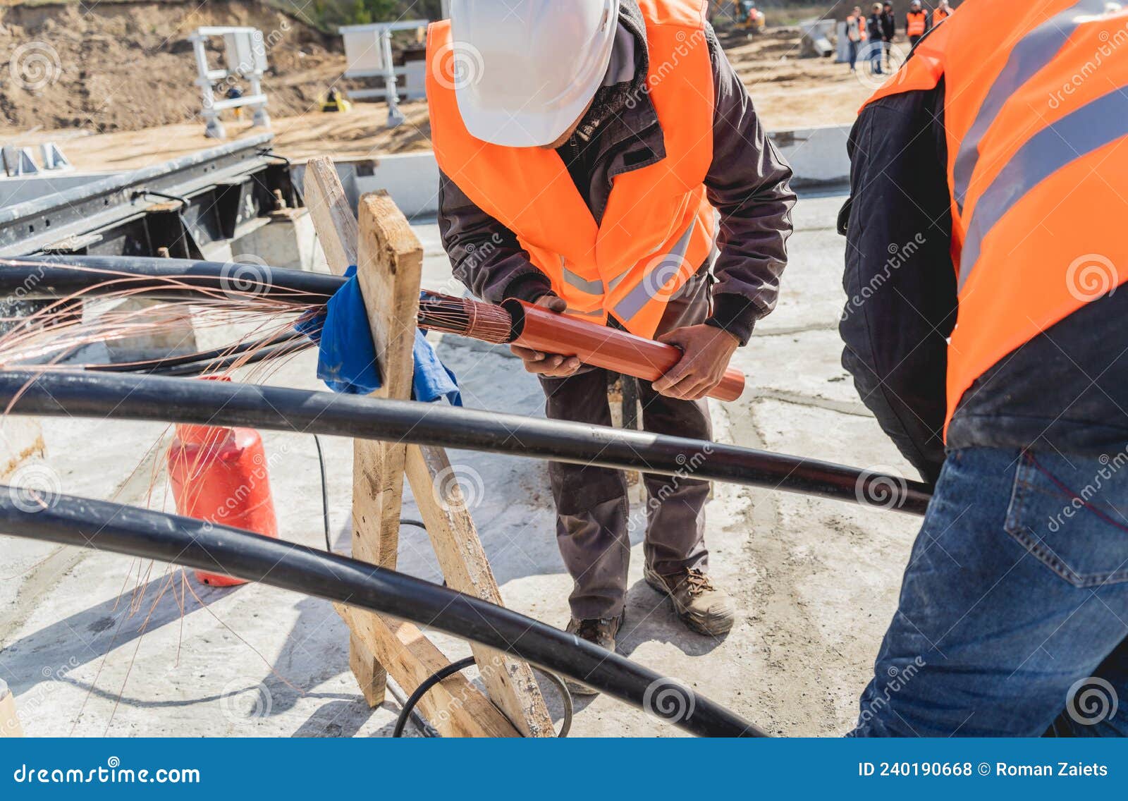 Two Electrician Builder Workers Installing High-voltage Cable Stock ...