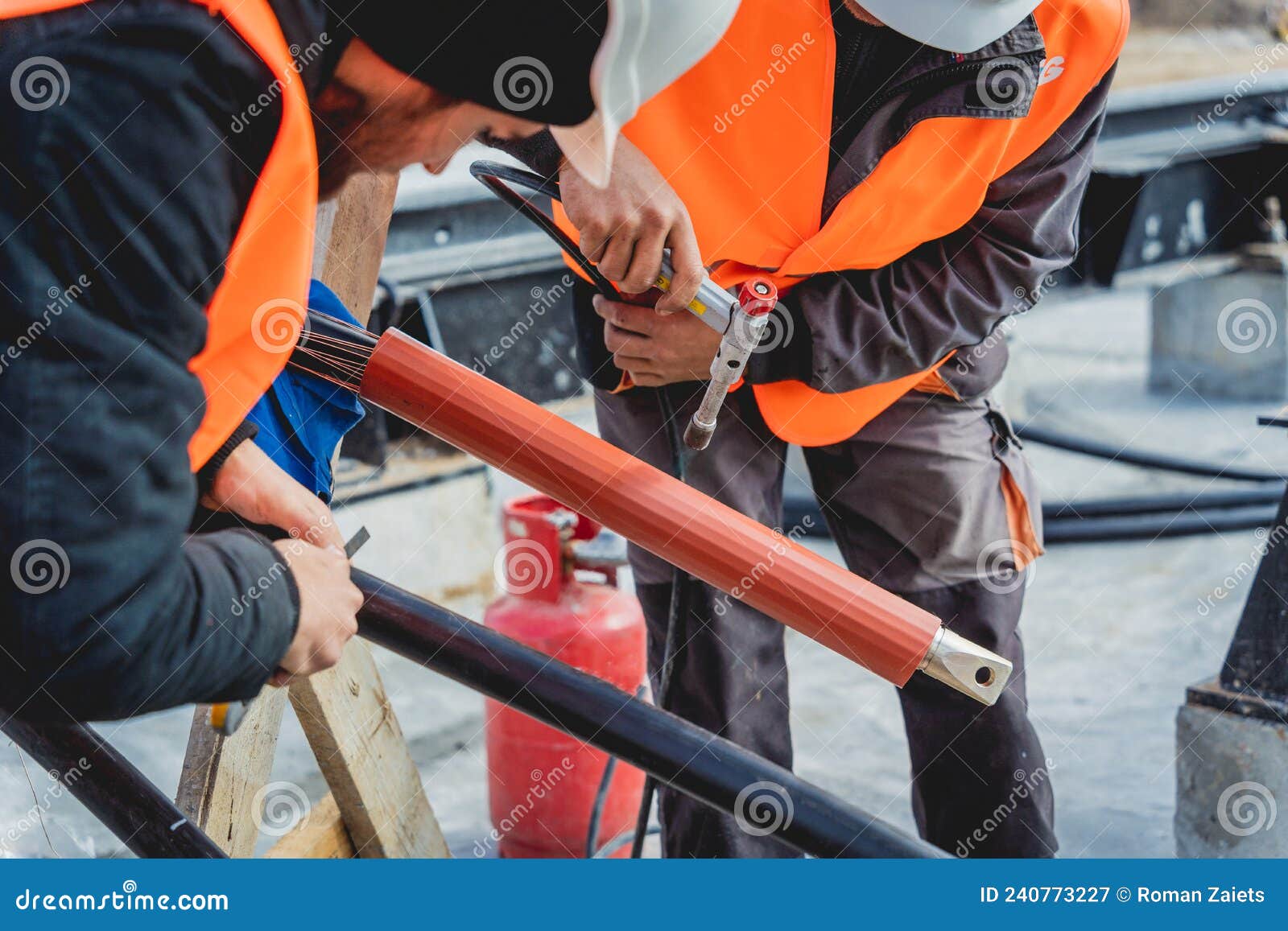 Two Electrician Builder Workers Installing High-voltage Cable Stock ...