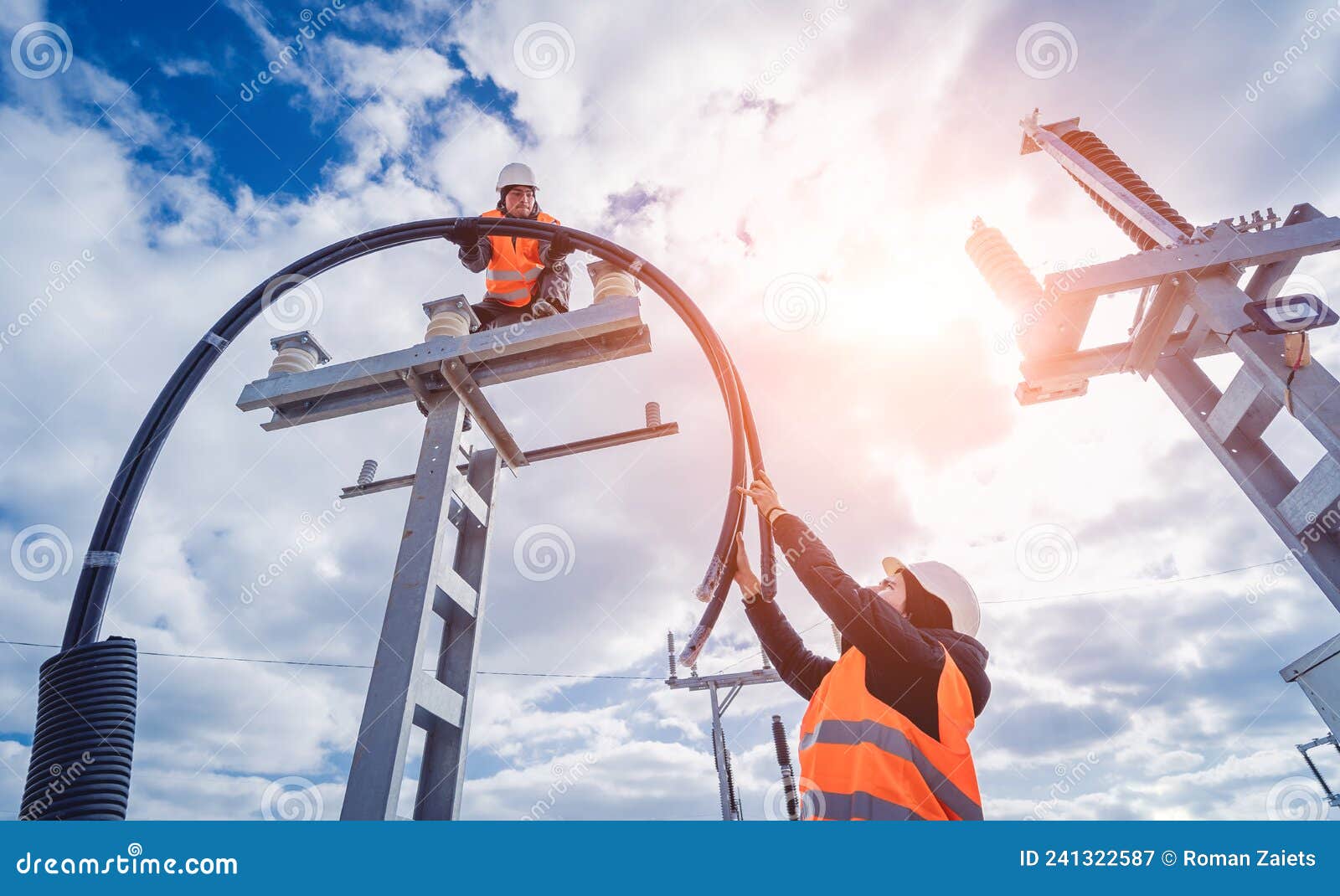Two Electrician Builder Workers Installing High-voltage Cable Stock ...