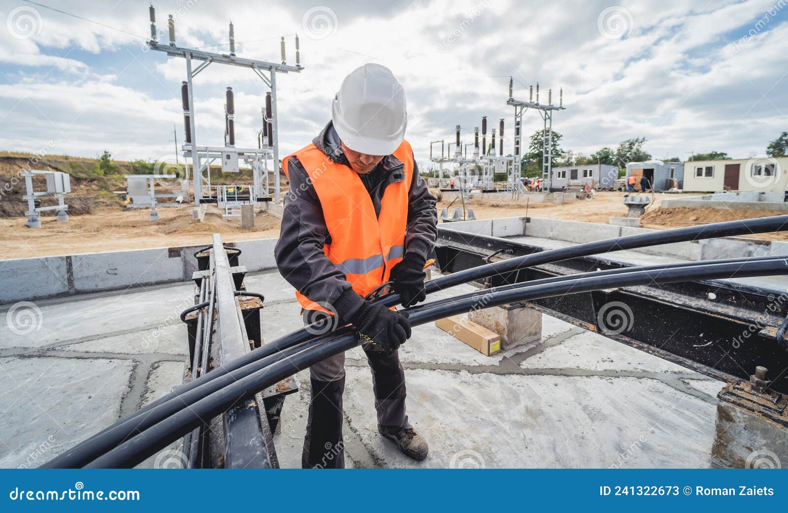 Two Electrician Builder Workers Installing High-voltage Cable Stock ...