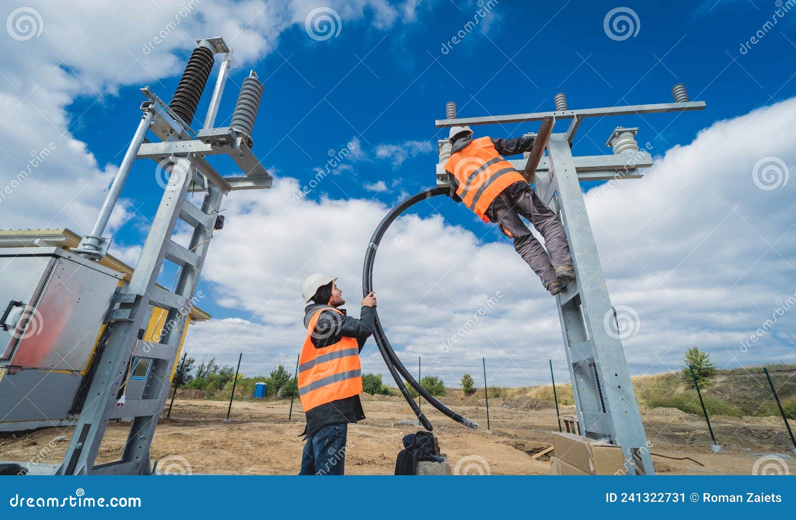 Two Electrician Builder Workers Installing High-voltage Cable Stock ...