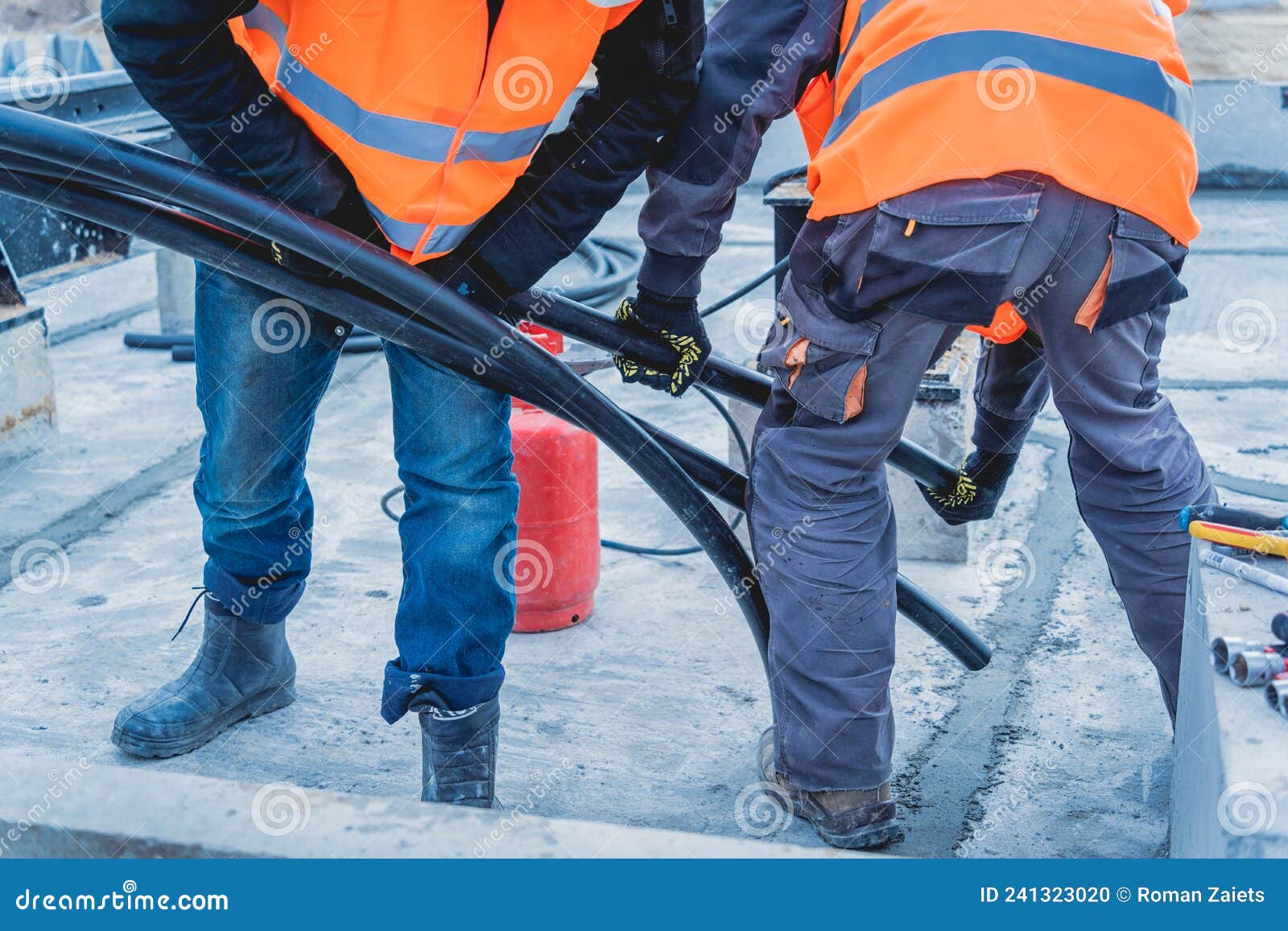Two Electrician Builder Workers Installing High-voltage Cable Stock ...