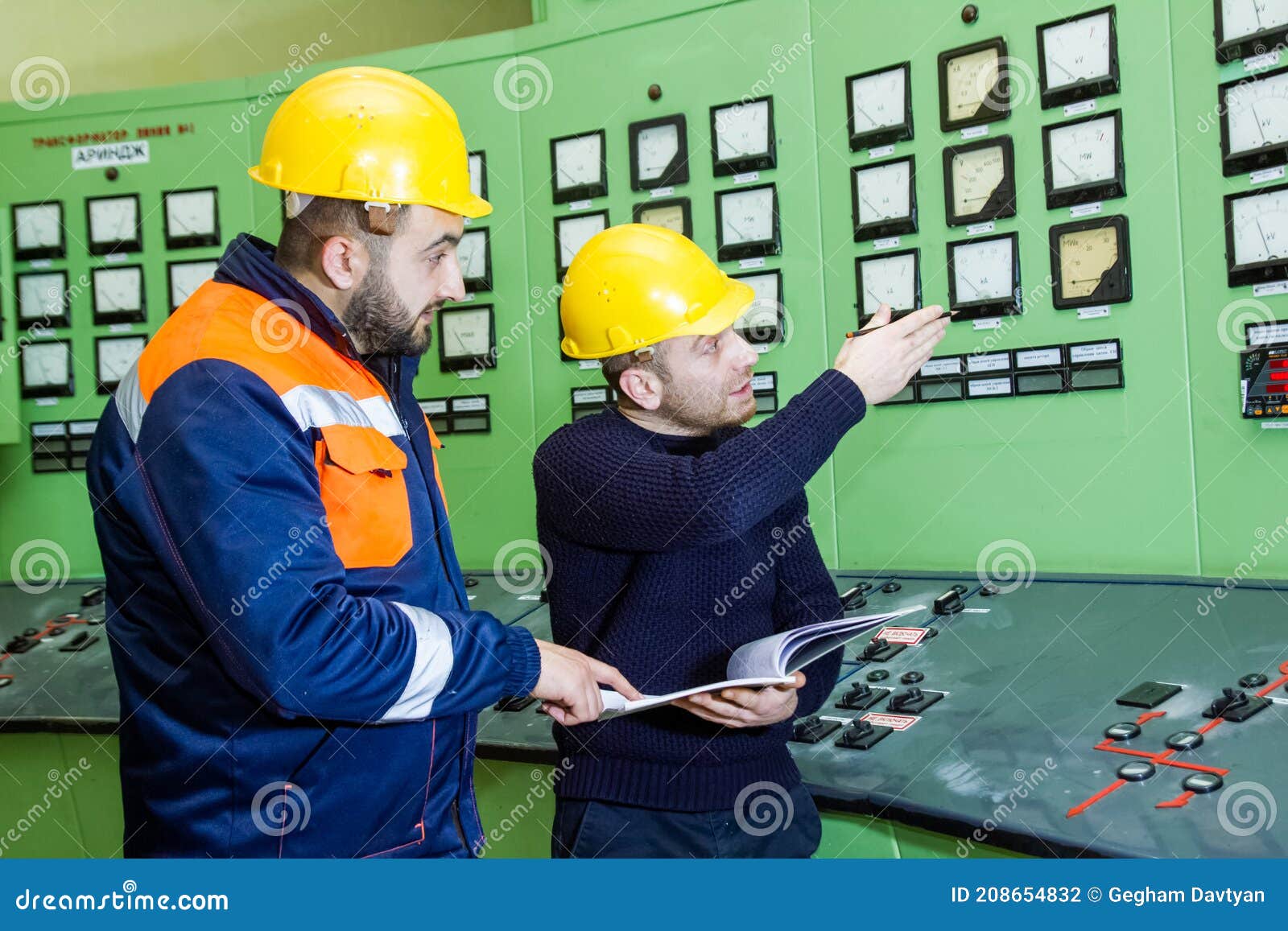 Electricians with Yellow Helmet Working in a Power Station Stock Photo ...
