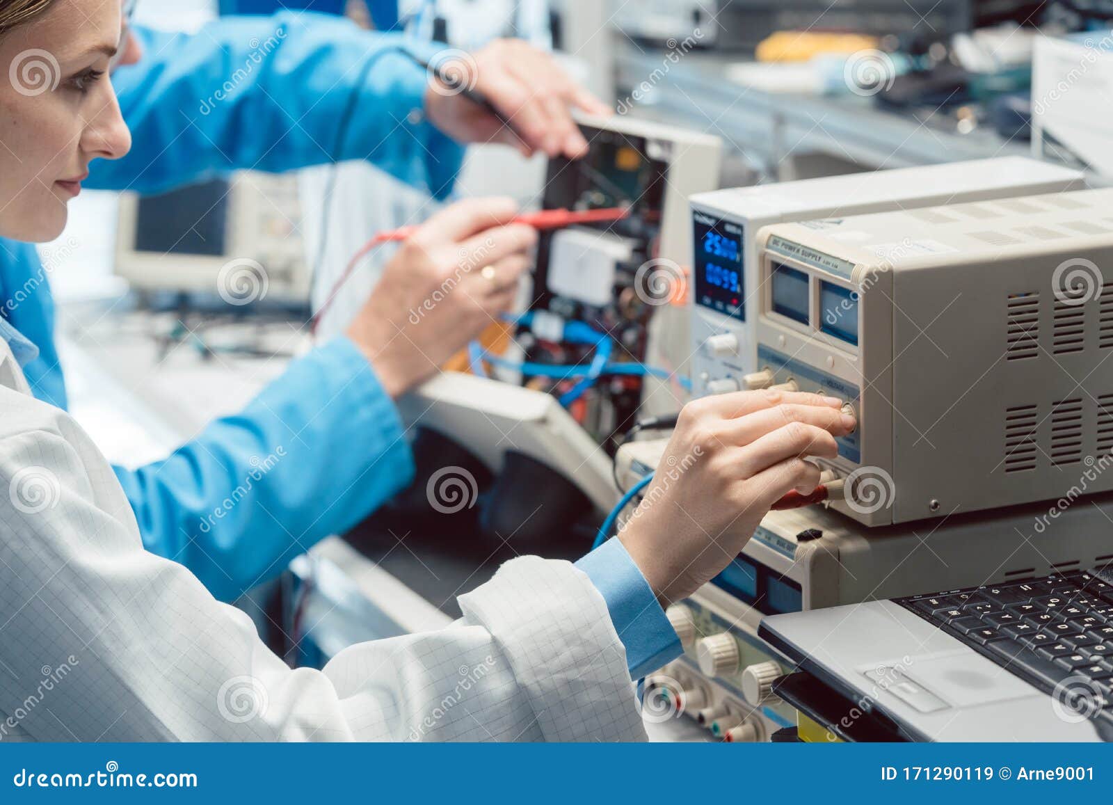Two Electronic Engineers on the Test Bench Measuring a New Product ...