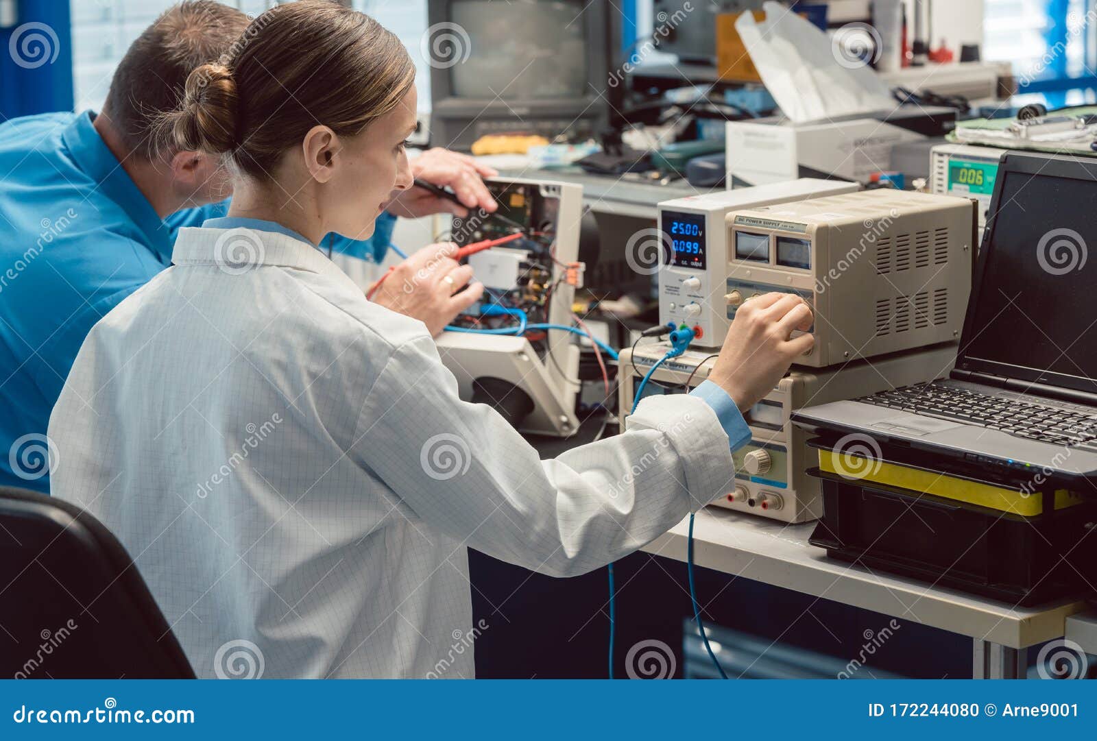 Two Electronic Engineers on the Test Bench Measuring a New Product ...