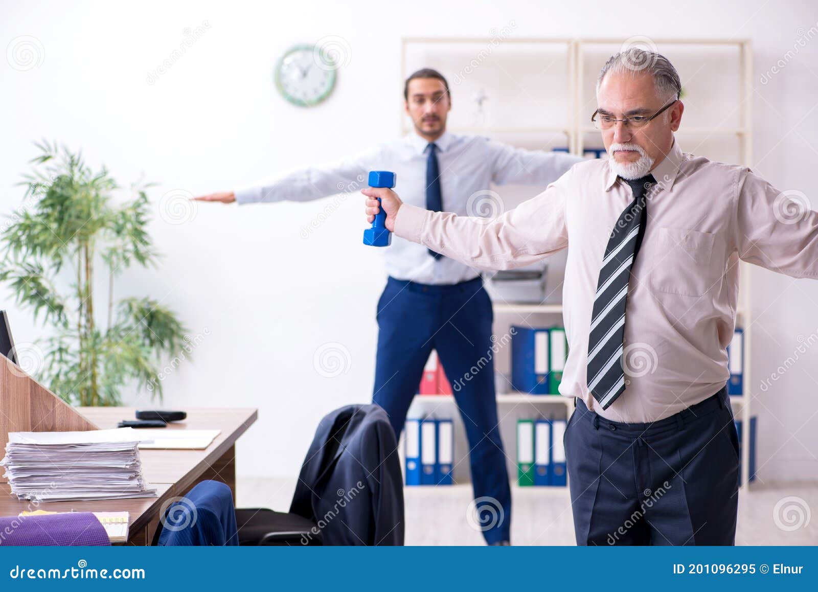 Two Employees Doing Physical Exercises at Workplace Stock Image - Image ...