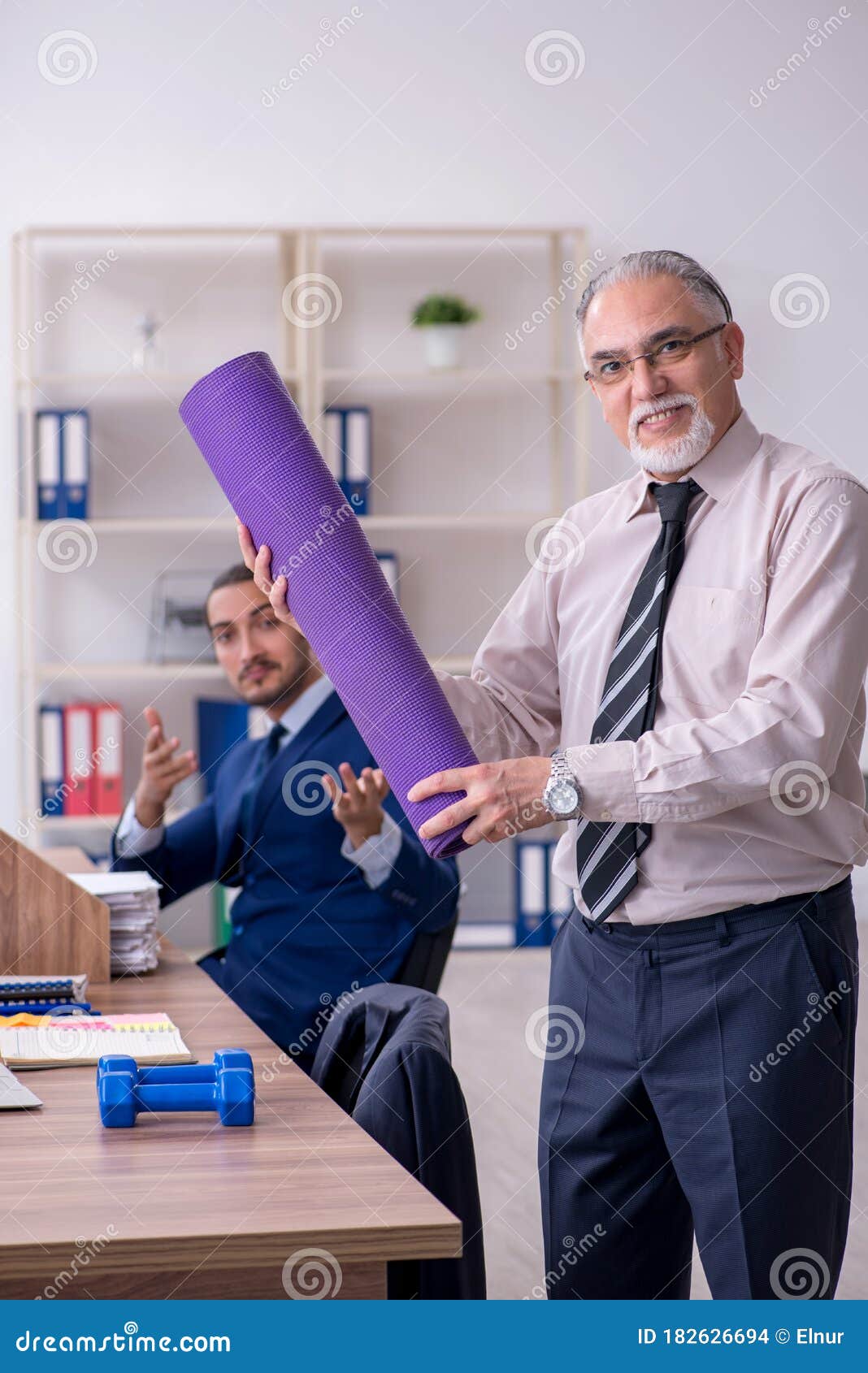 Two Employees Doing Physical Exercises at Workplace Stock Photo - Image ...