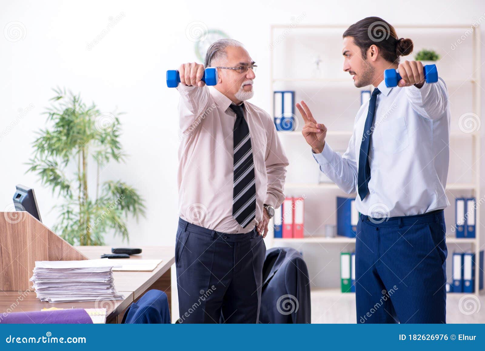 Two Employees Doing Sport Exercises In The Office Royalty-Free Stock ...
