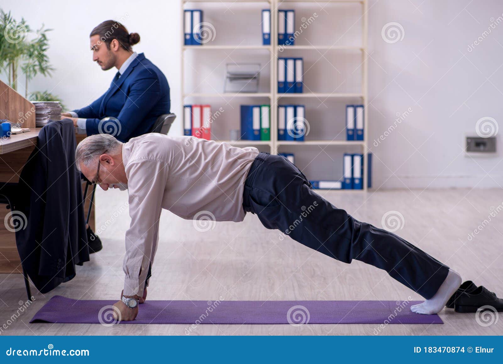 Two Employees Doing Physical Exercises at Workplace Stock Photo - Image ...