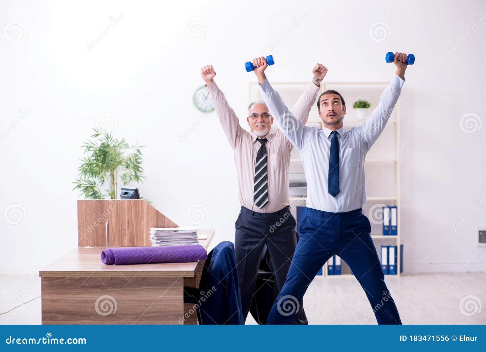 Two Employees Doing Physical Exercises at Workplace Stock Photo - Image ...