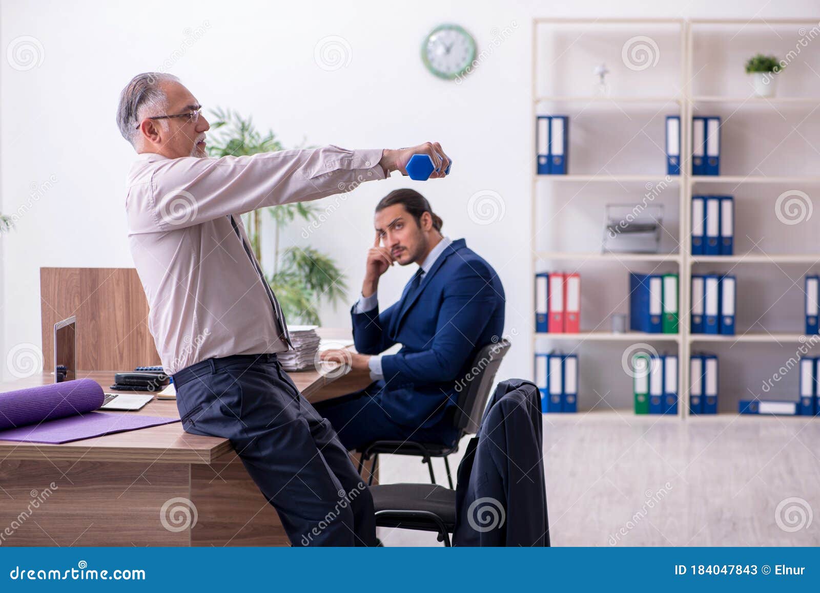 Two Employees Doing Physical Exercises at Workplace Stock Image - Image ...