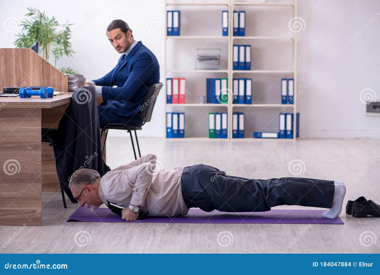 Two Employees Doing Physical Exercises at Workplace Stock Photo - Image ...