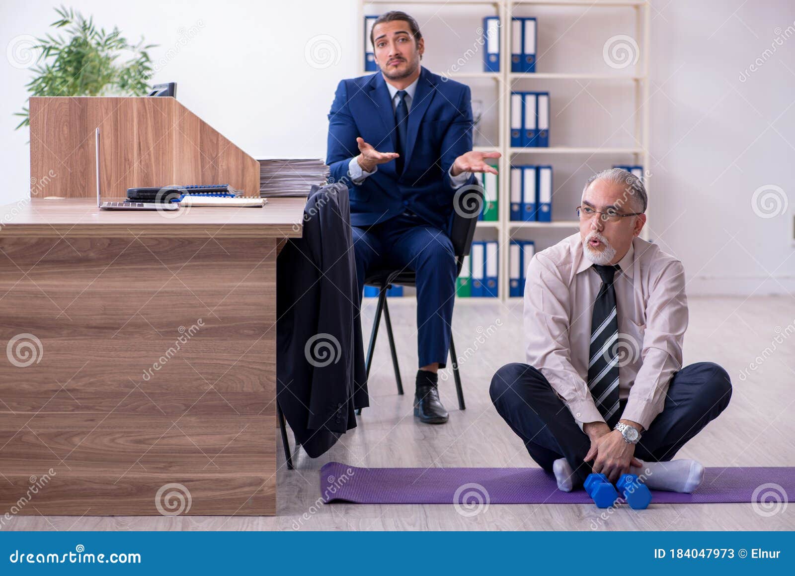 Two Employees Doing Physical Exercises at Workplace Stock Image - Image ...