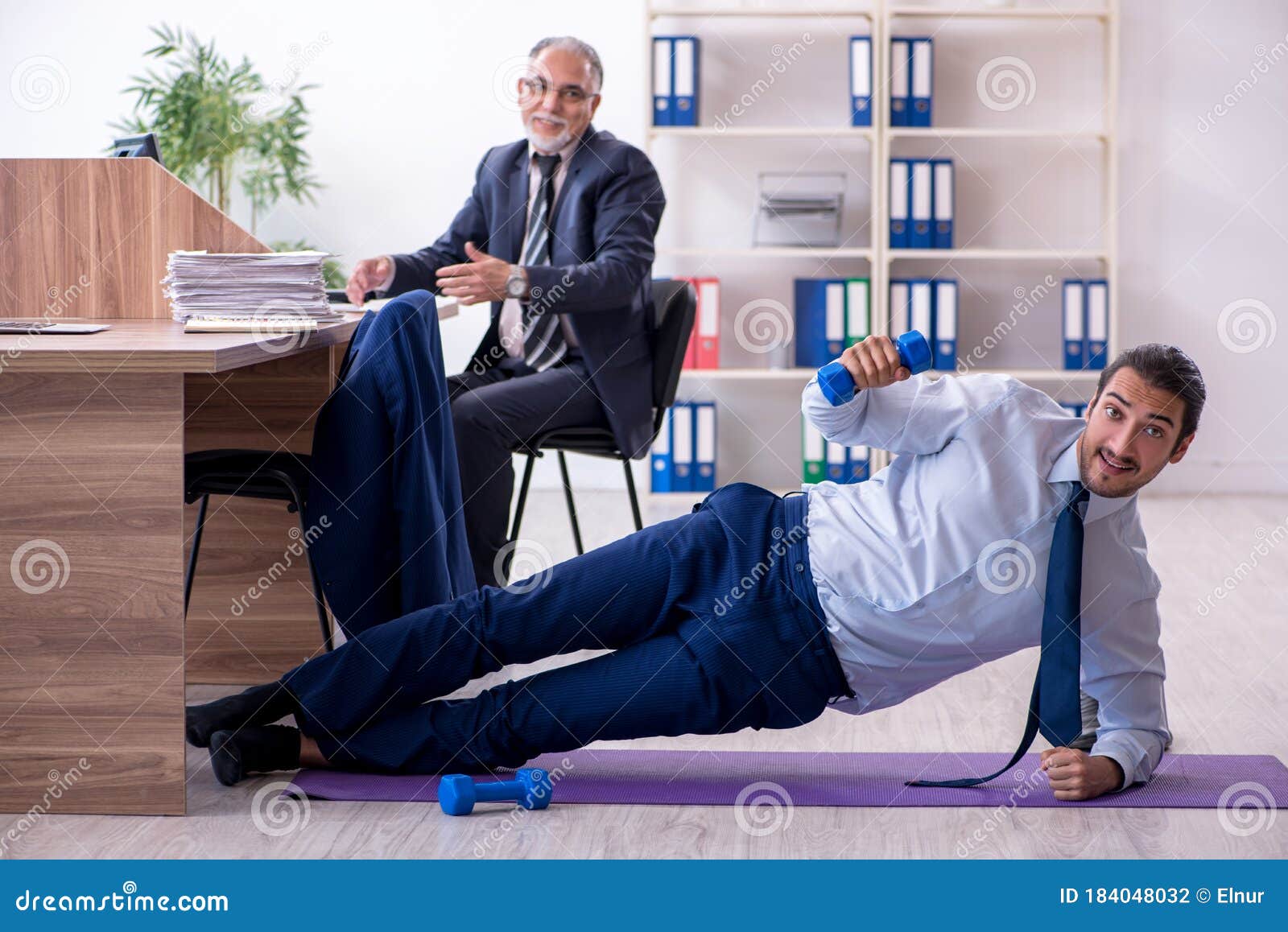 Two Employees Doing Physical Exercises at Workplace Stock Photo - Image ...