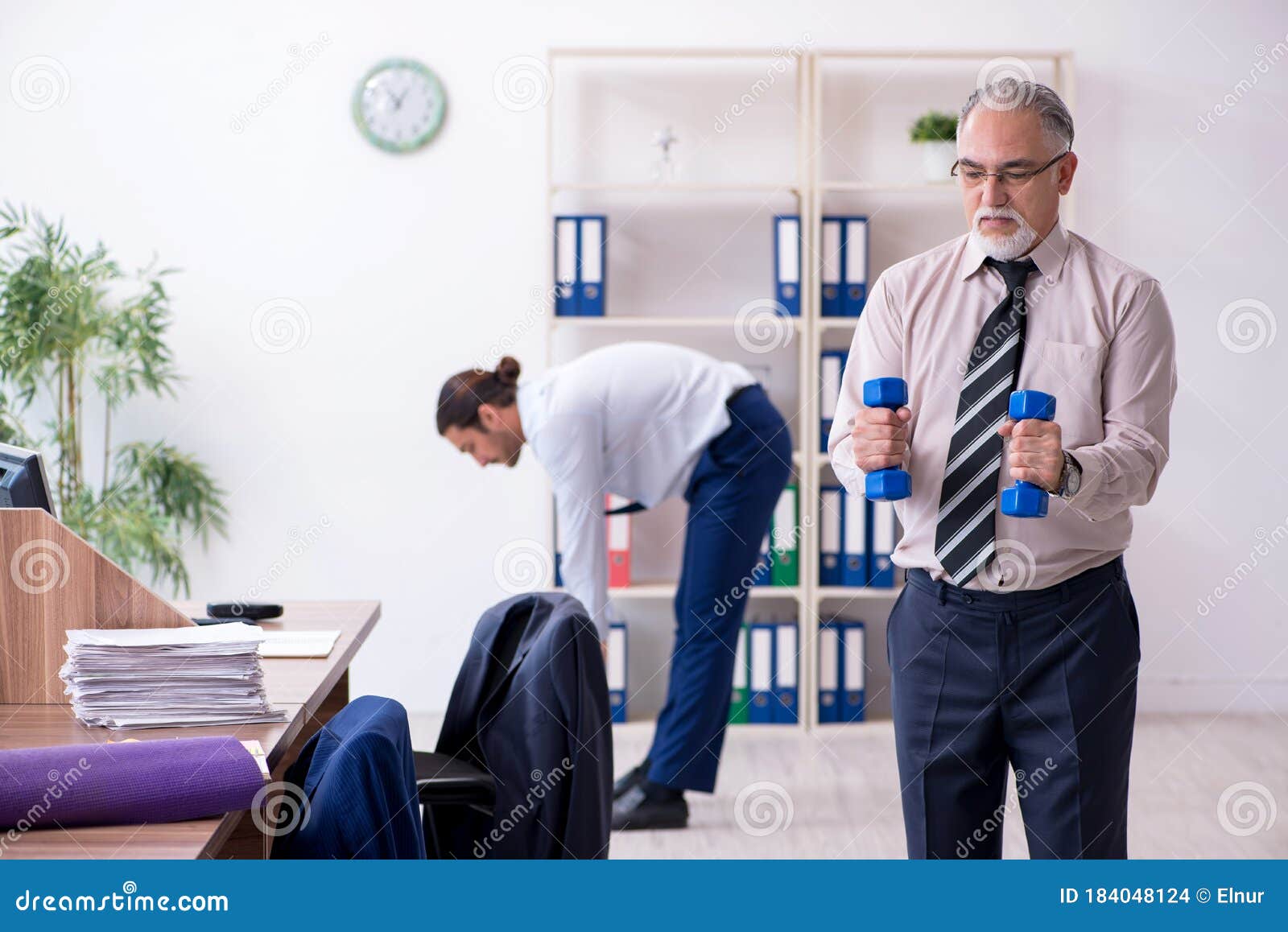 Two Employees Doing Physical Exercises at Workplace Stock Photo - Image ...