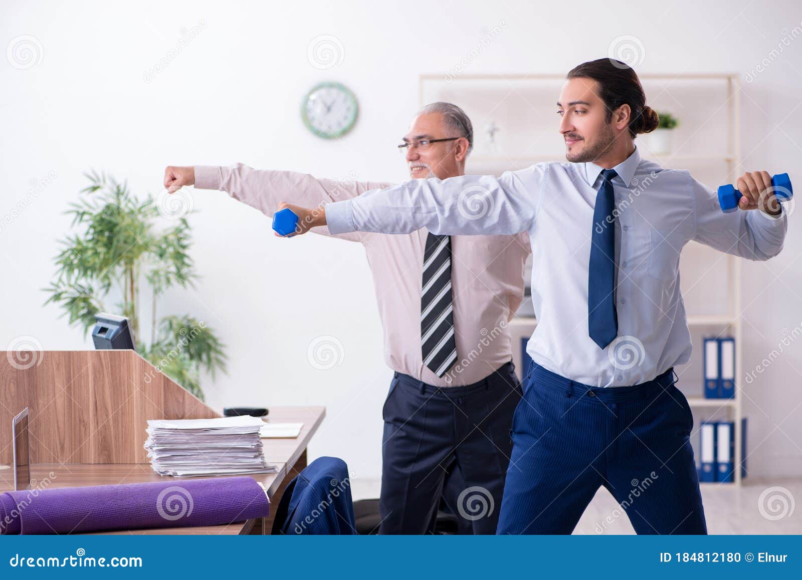 Two Employees Doing Physical Exercises at Workplace Stock Photo - Image ...