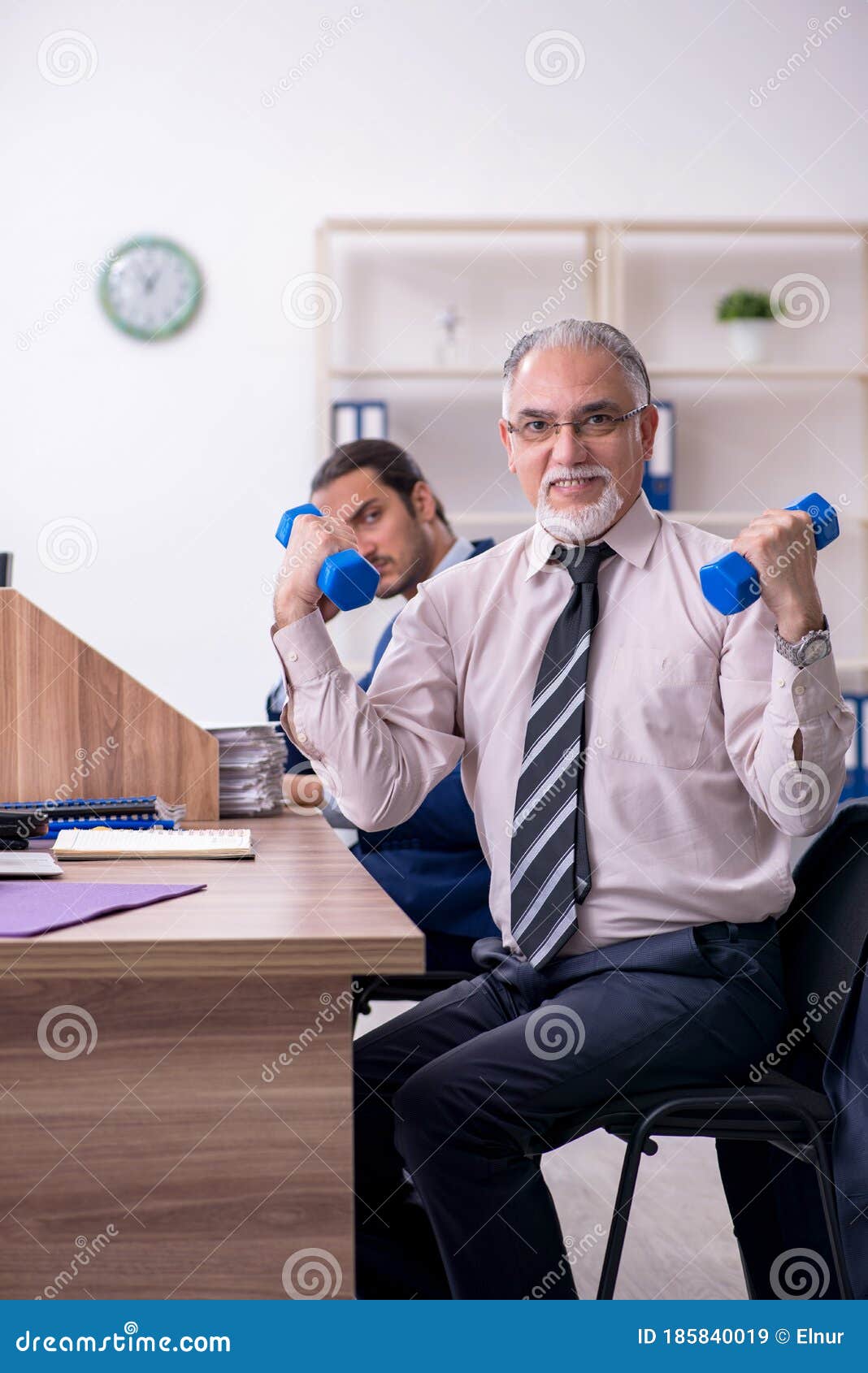 Two Employees Doing Physical Exercises at Workplace Stock Image - Image ...