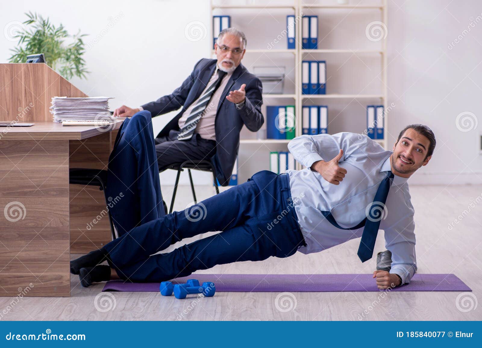 Two Employees Doing Physical Exercises at Workplace Stock Image - Image ...