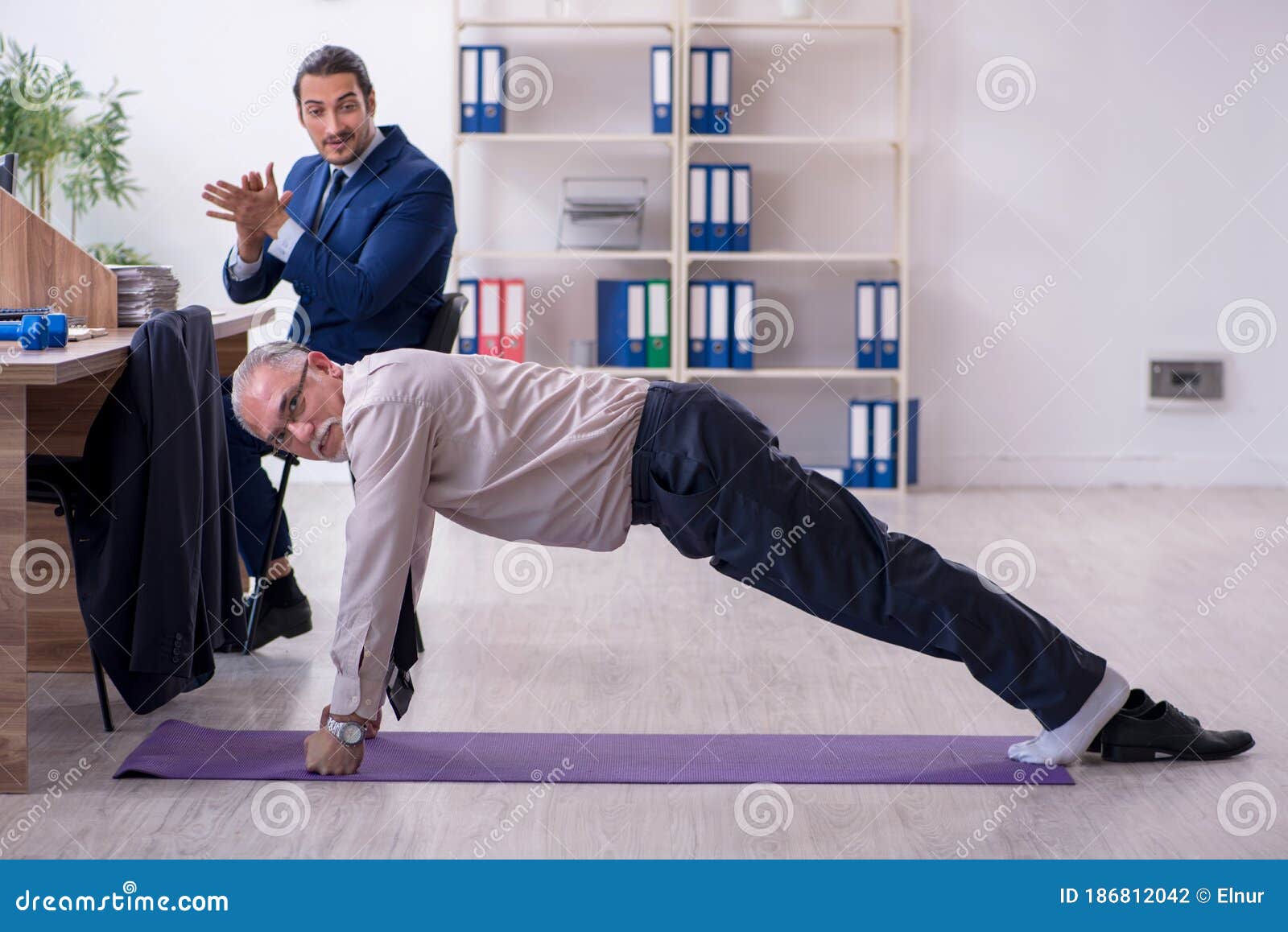 Two Employees Doing Physical Exercises at Workplace Stock Photo - Image ...