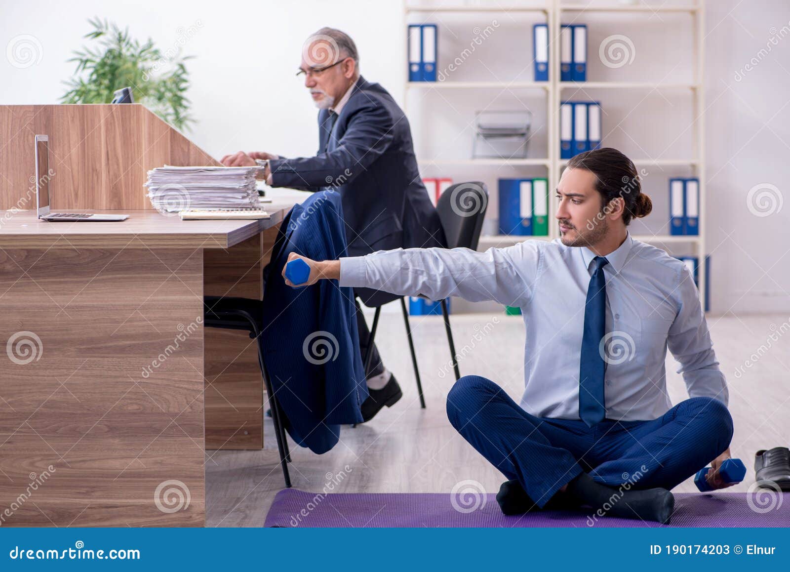 Two Employees Doing Physical Exercises at Workplace Stock Image - Image ...