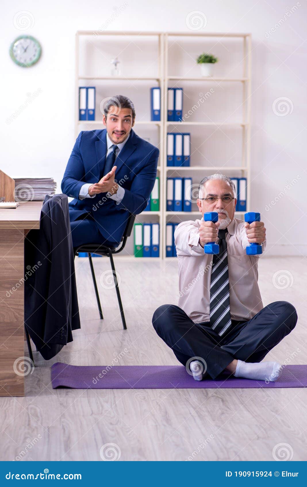 Two Employees Doing Physical Exercises at Workplace Stock Photo - Image ...