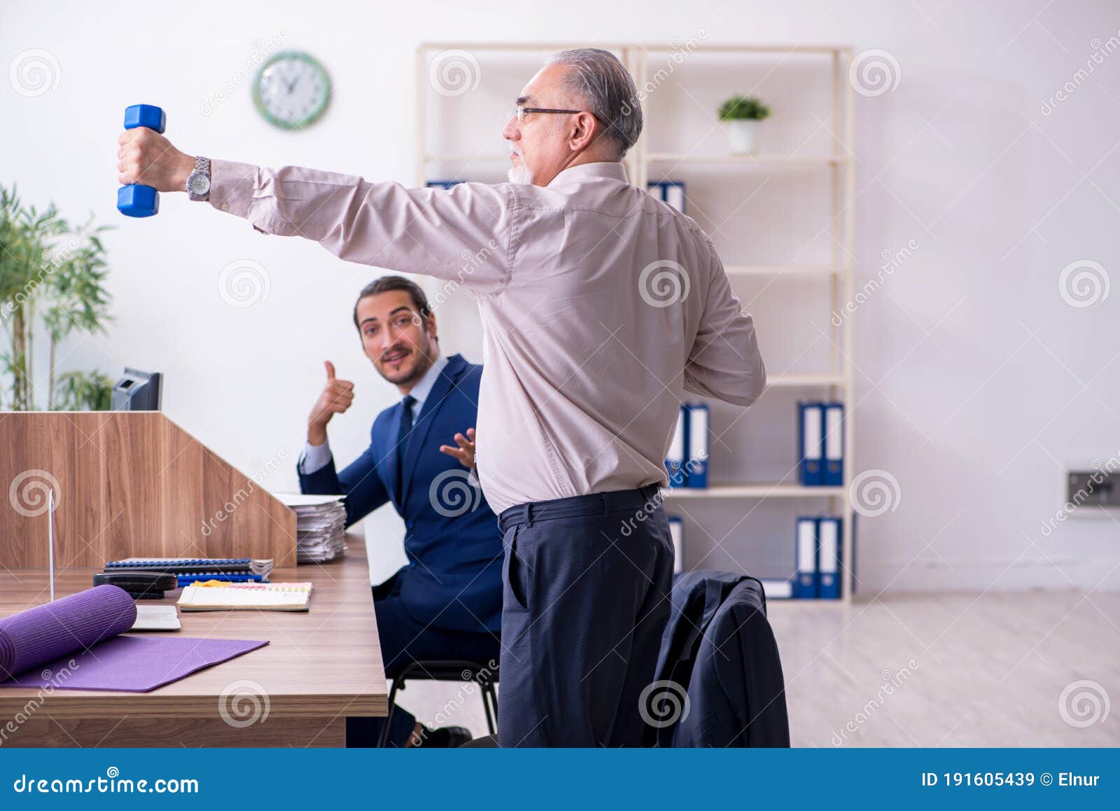 Two Employees Doing Physical Exercises at Workplace Stock Image - Image ...